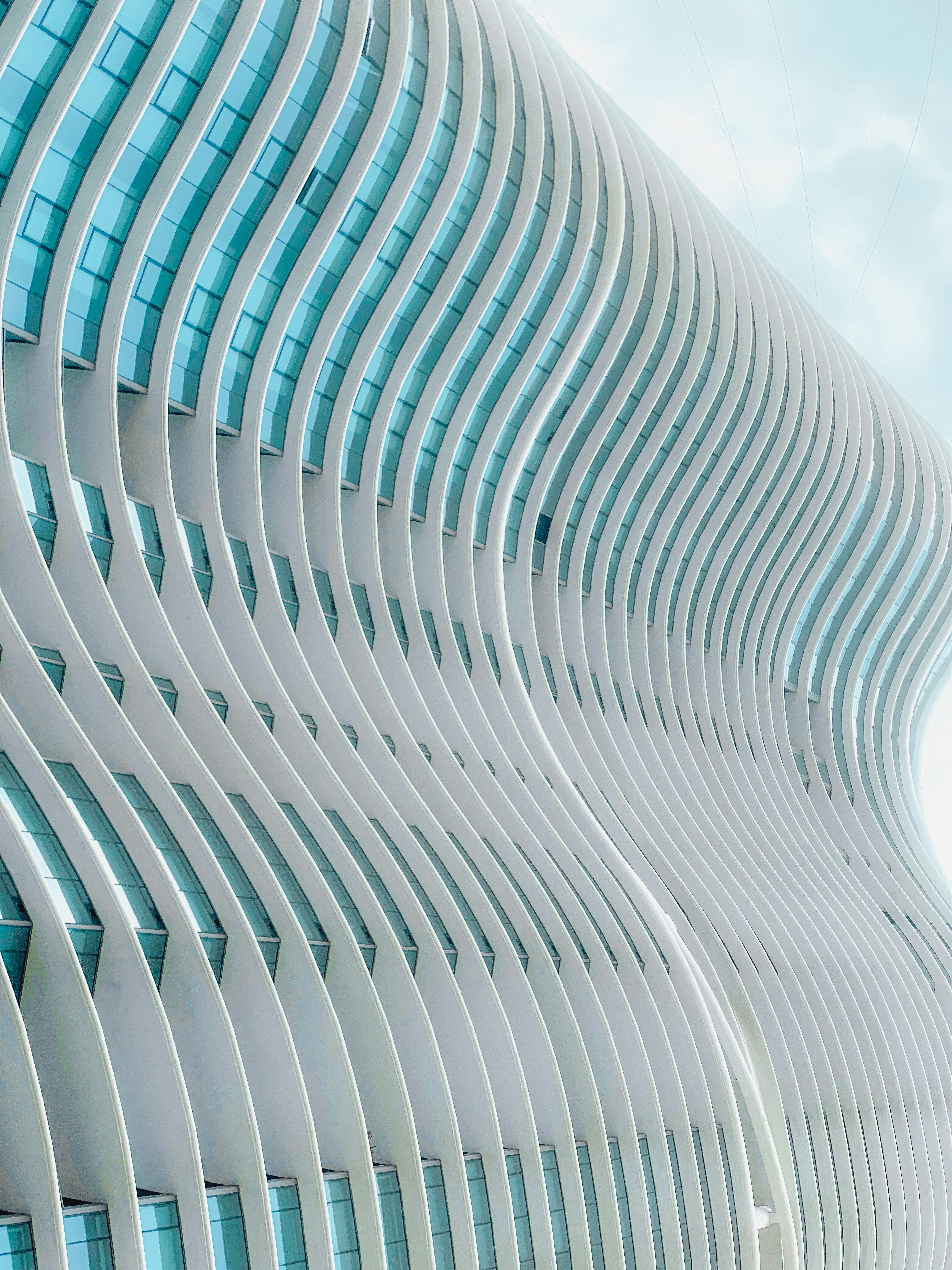 A tall building with a wavy design on it's side photo – Free The ritz ...