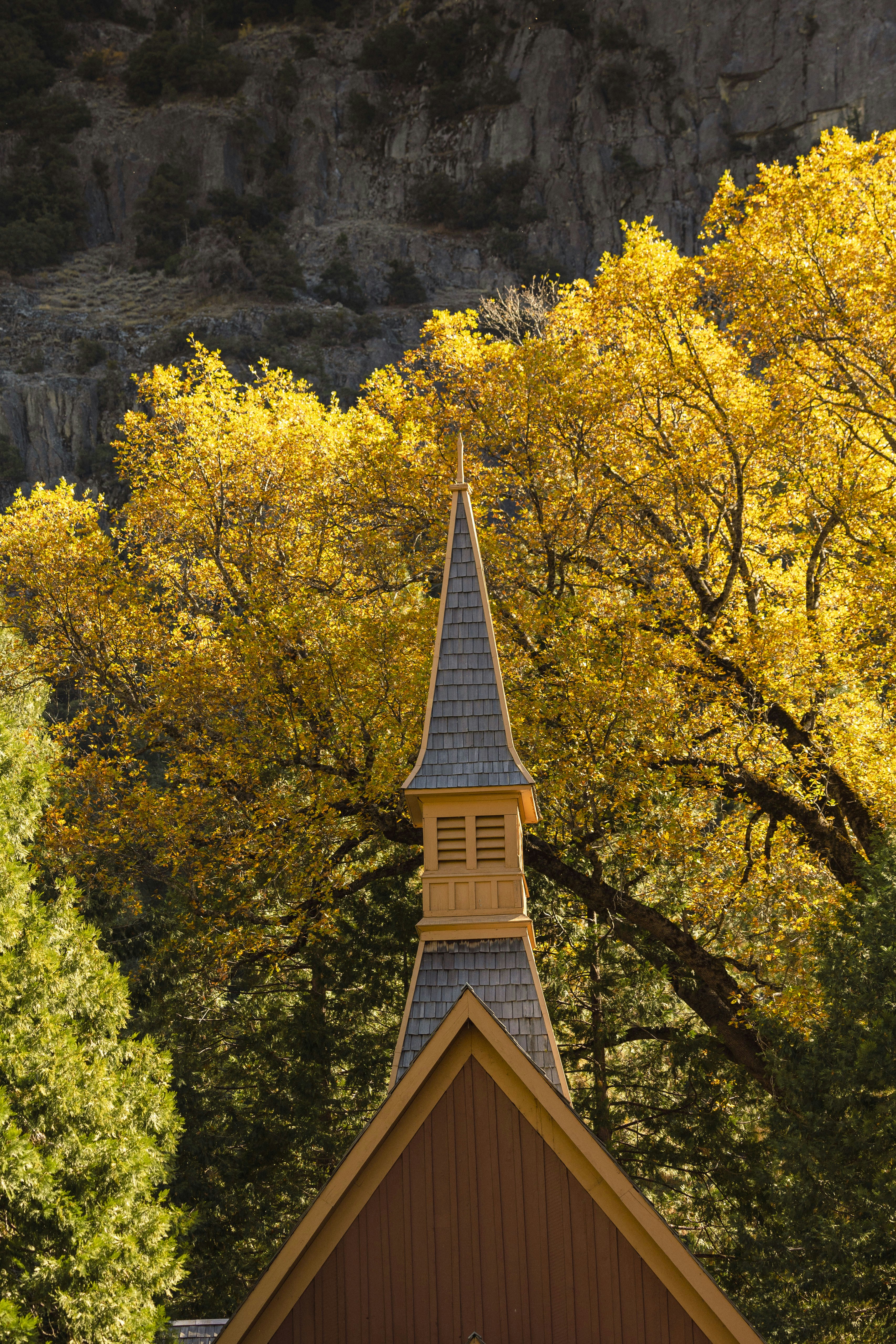 Golden-steepled chapel rising among autumn gold