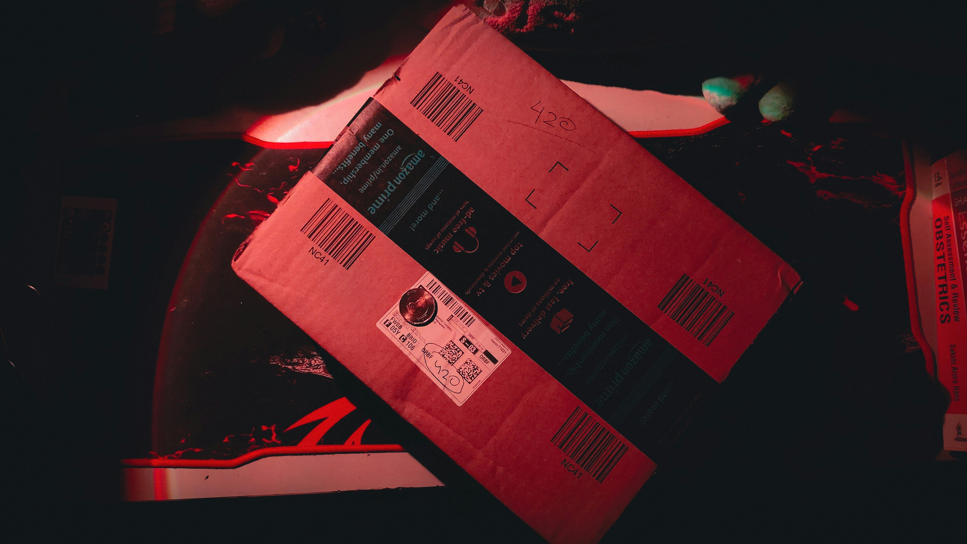 A stack of red boxes sitting on top of a table photo – Free Paper Image ...
