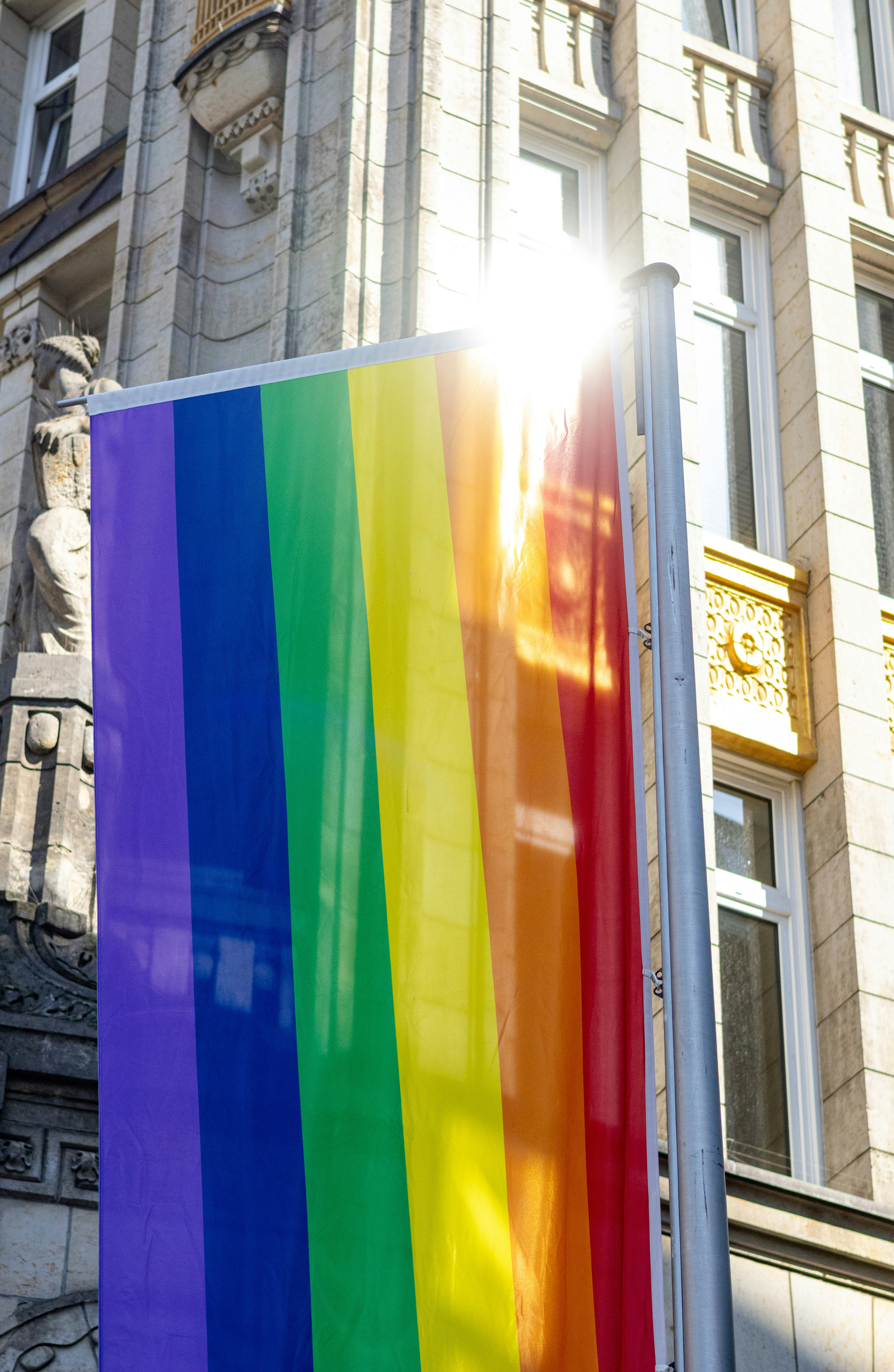 Flag of Pride Against a Historic Facade