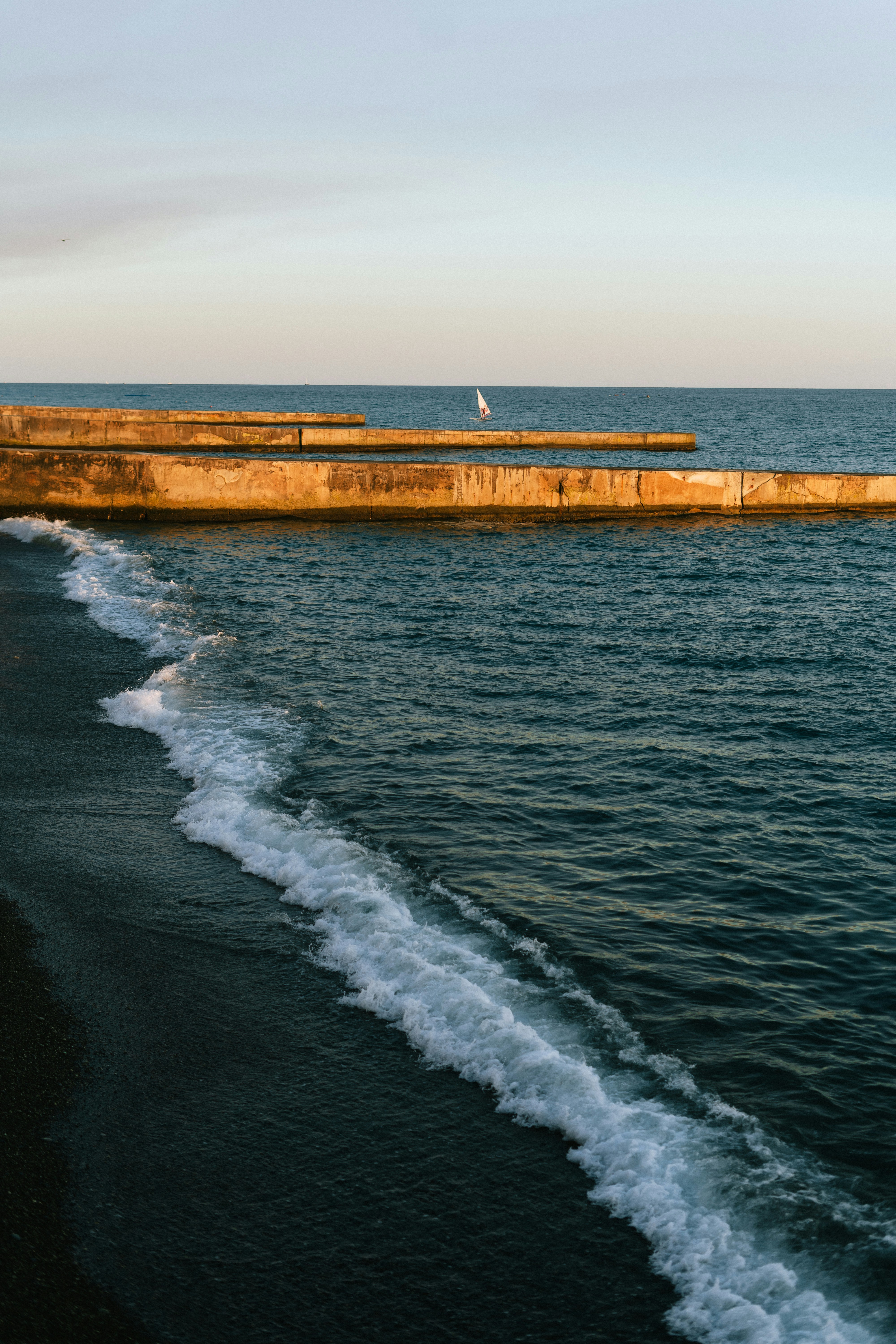 A pier on the shore of a large body of water photo – Free Adler ...