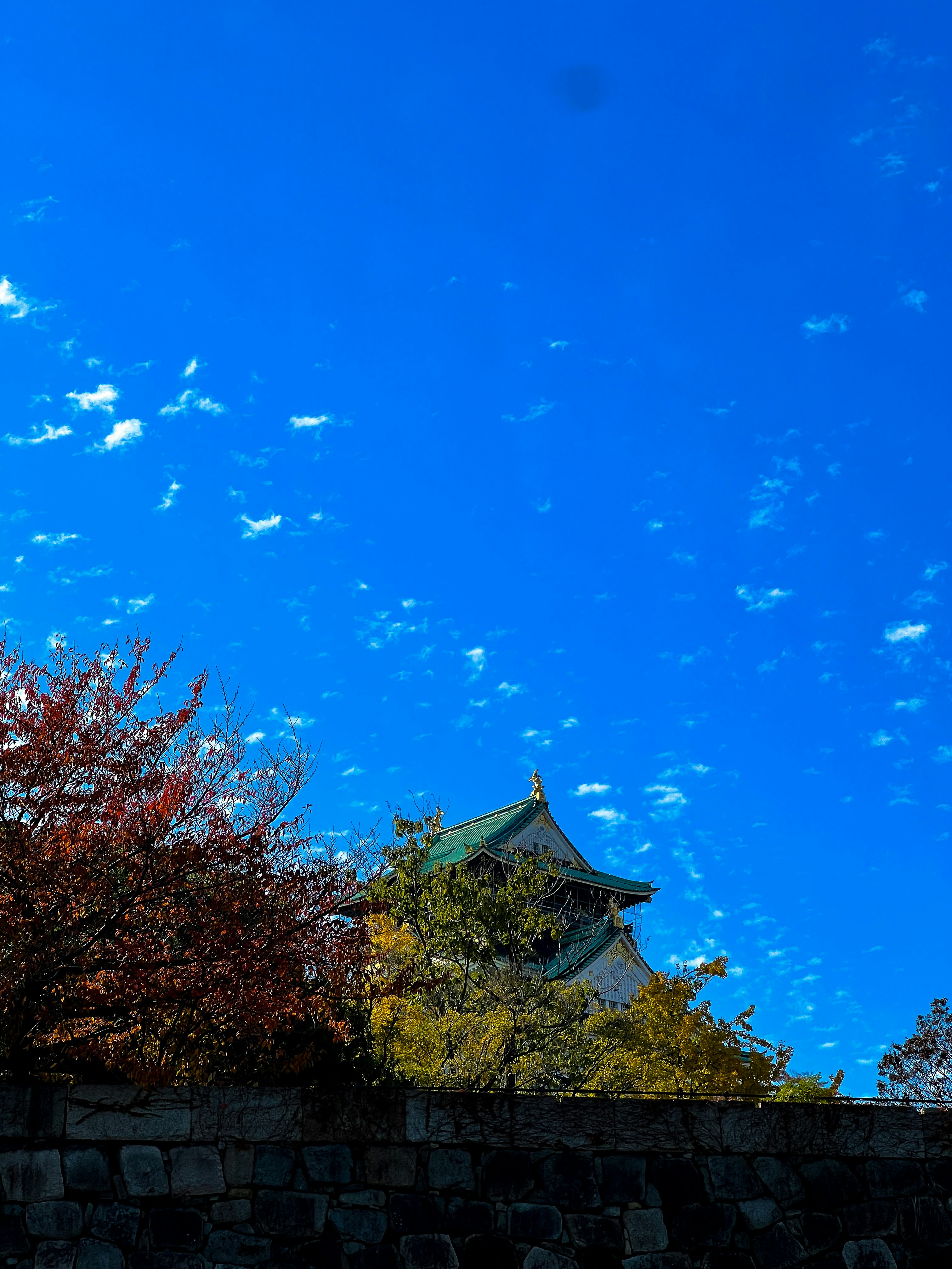 A clock tower towering over a brick wall photo – Free Osaka Image on ...