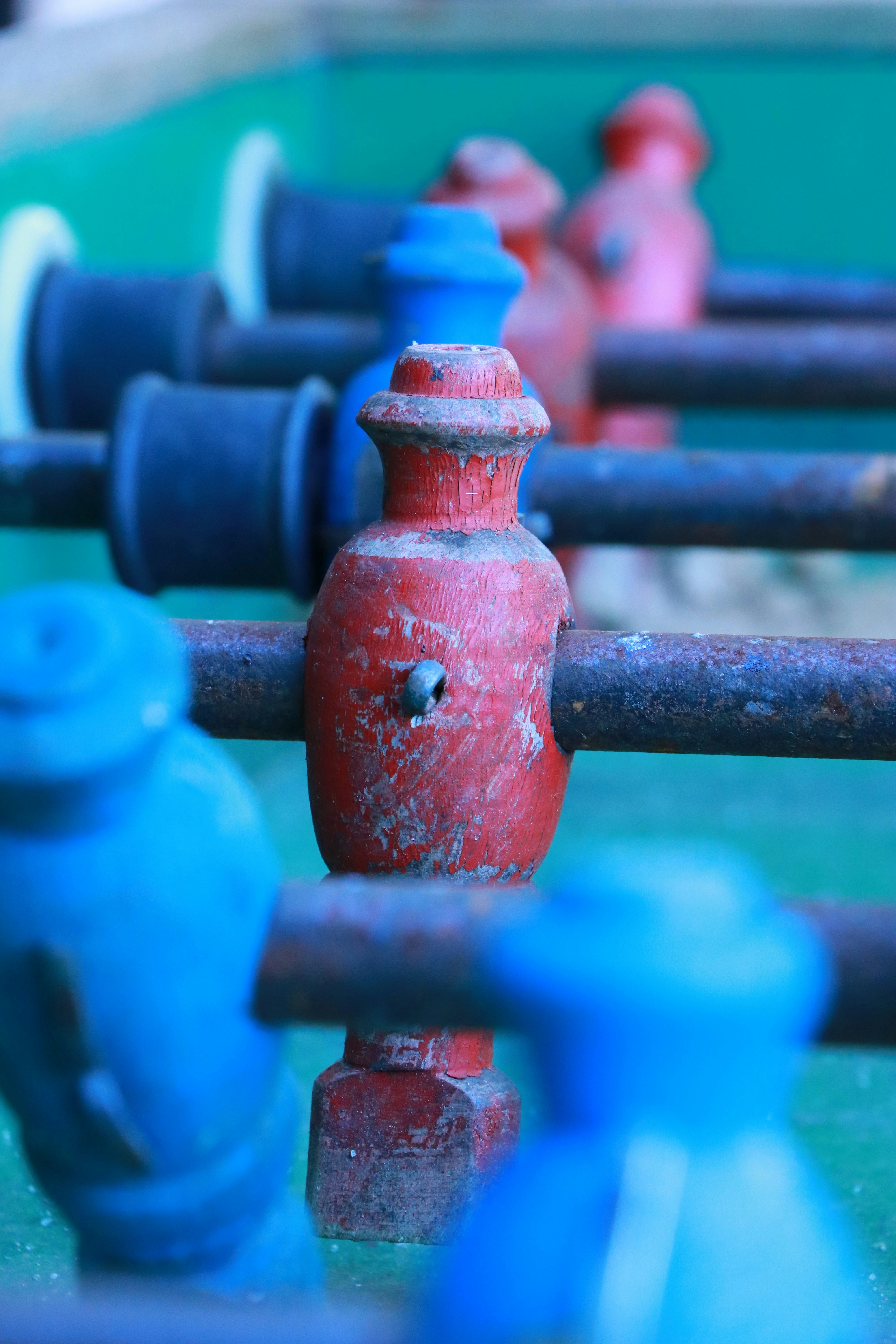 A row of blue and red fire hydrants sitting next to each other photo ...