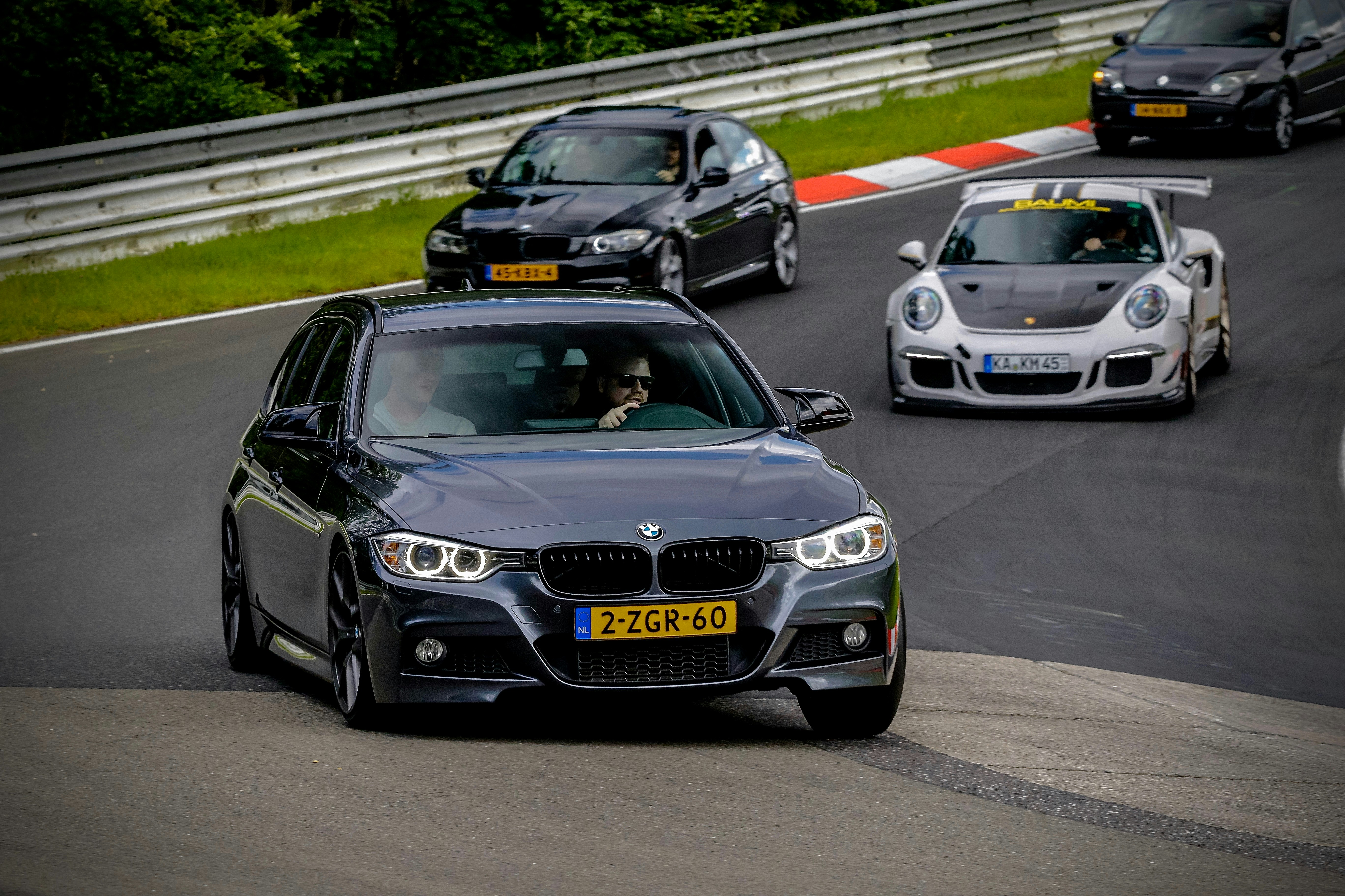 A group of cars driving down a race track photo – Free Nürburgring ...