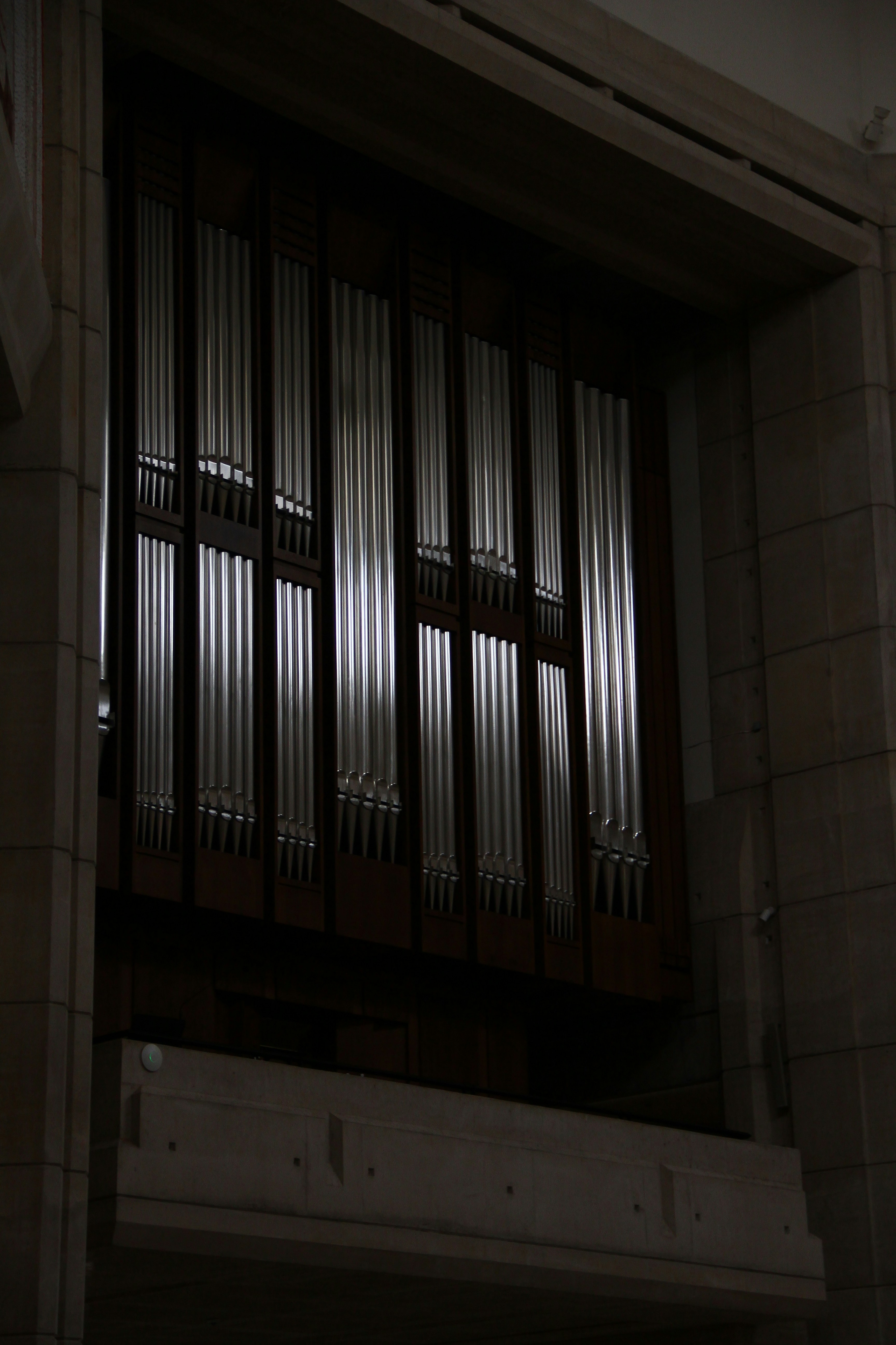 A pipe organ is seen through a window photo – Free Building Image on ...