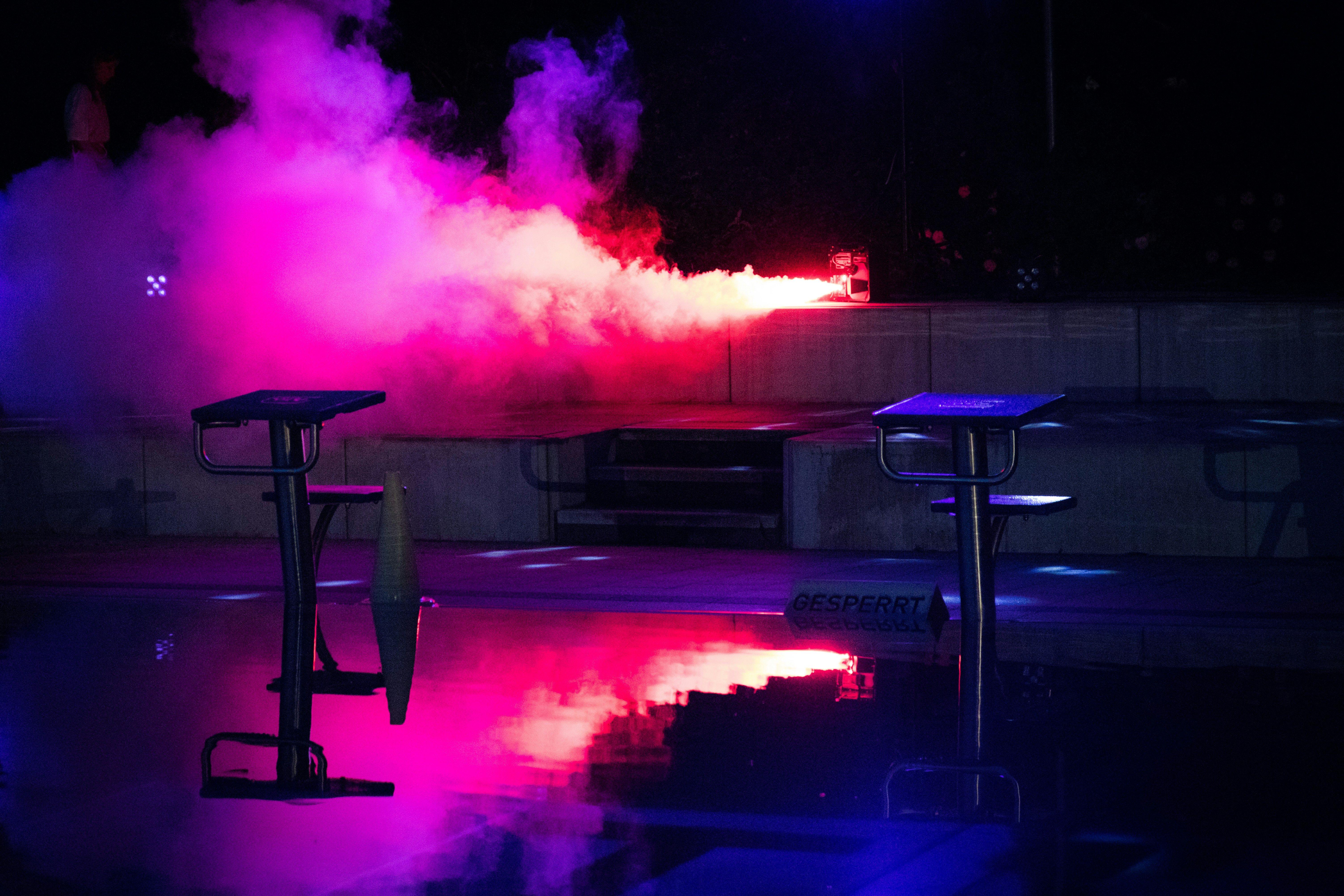 Neon Vapor over a Quiet Pool: Pulse of Red and Violet
