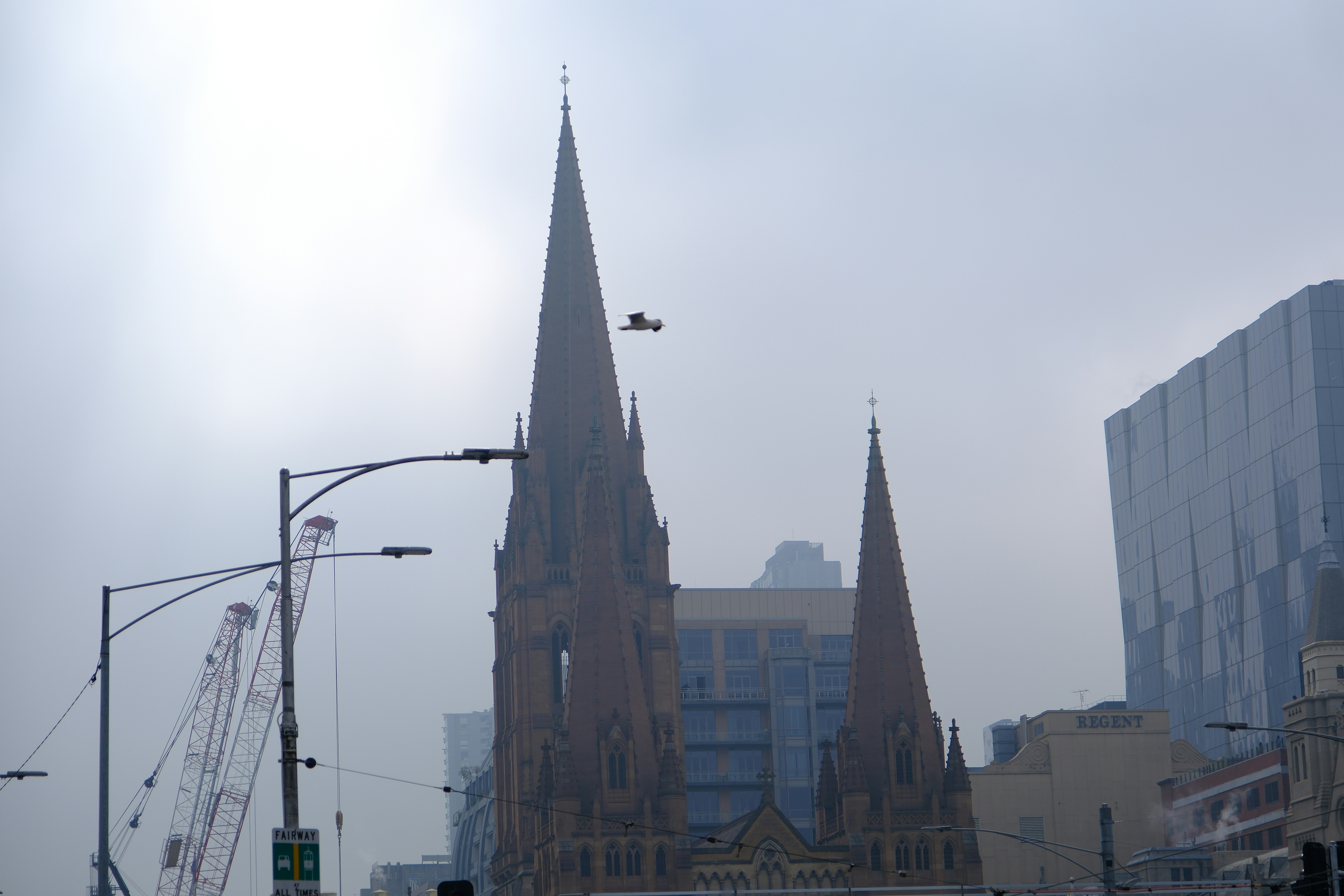 Fogbound Hover: Helicopter Between Cathedral Spires