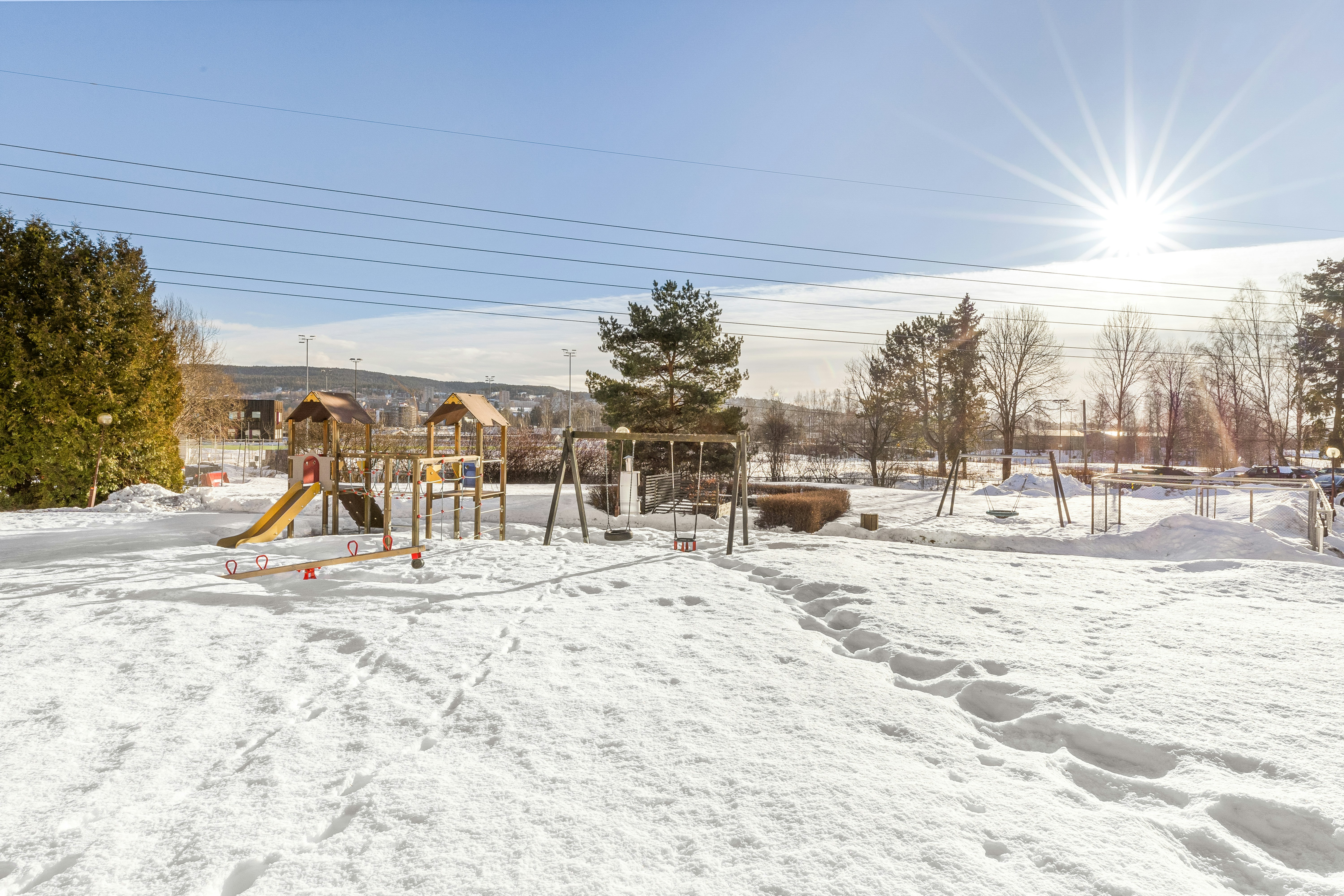 A snow covered park with a slide and a playground photo – Free Outdoor ...