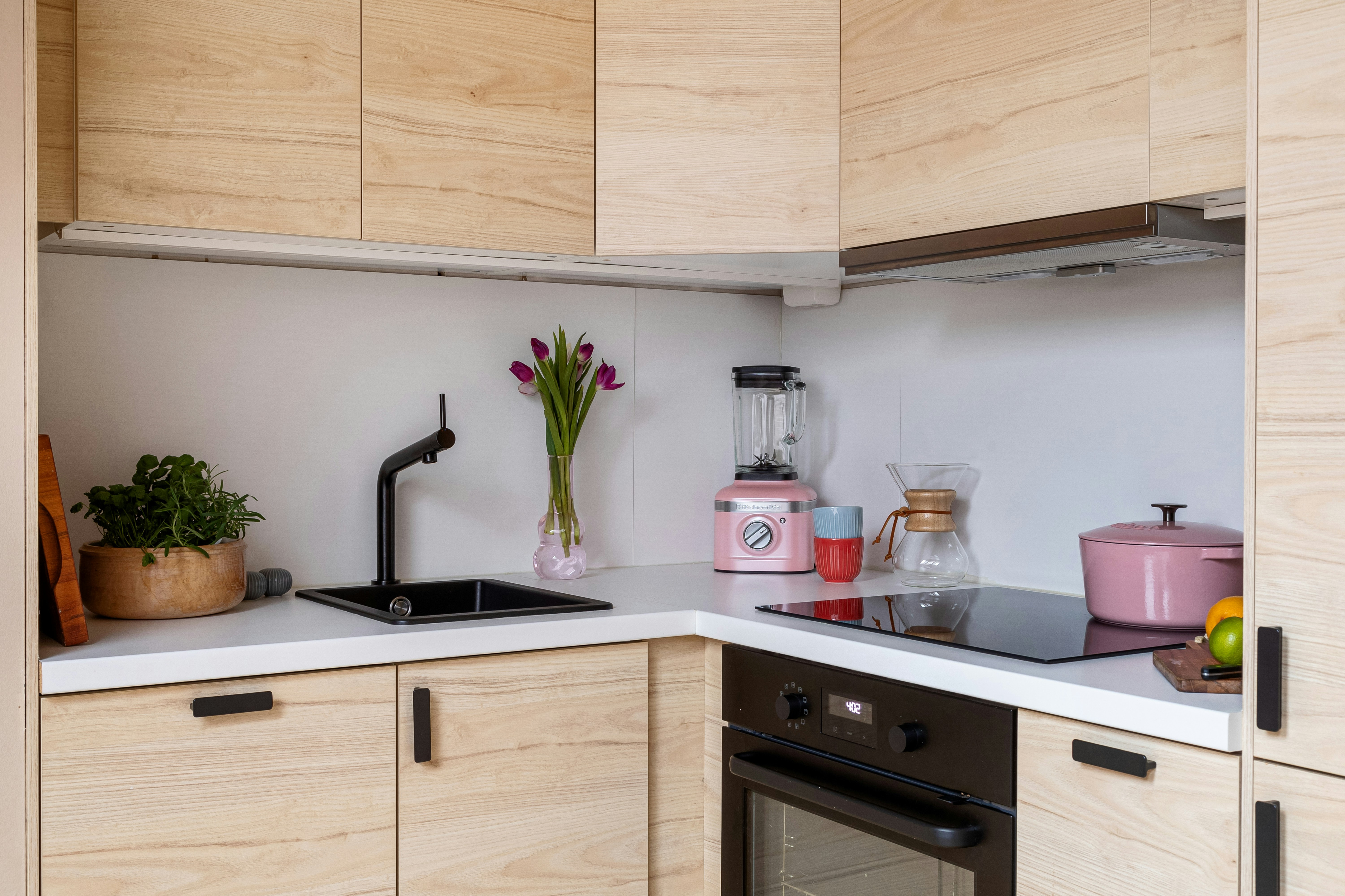 A kitchen with wooden cabinets and white counter tops photo – Free ...