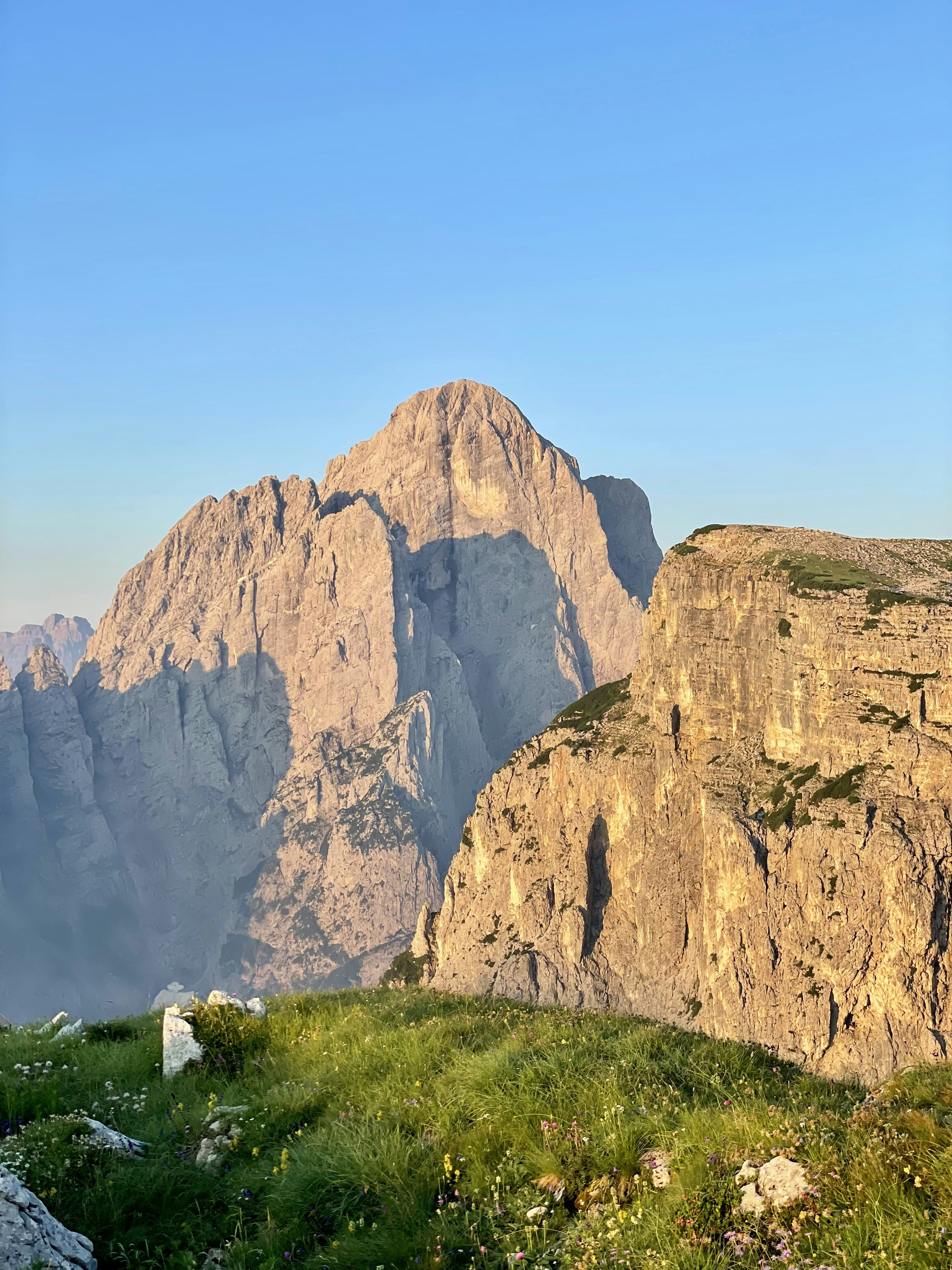 Crown of Granite: Sunlit Peaks Over a Quiet Alpine Verge
