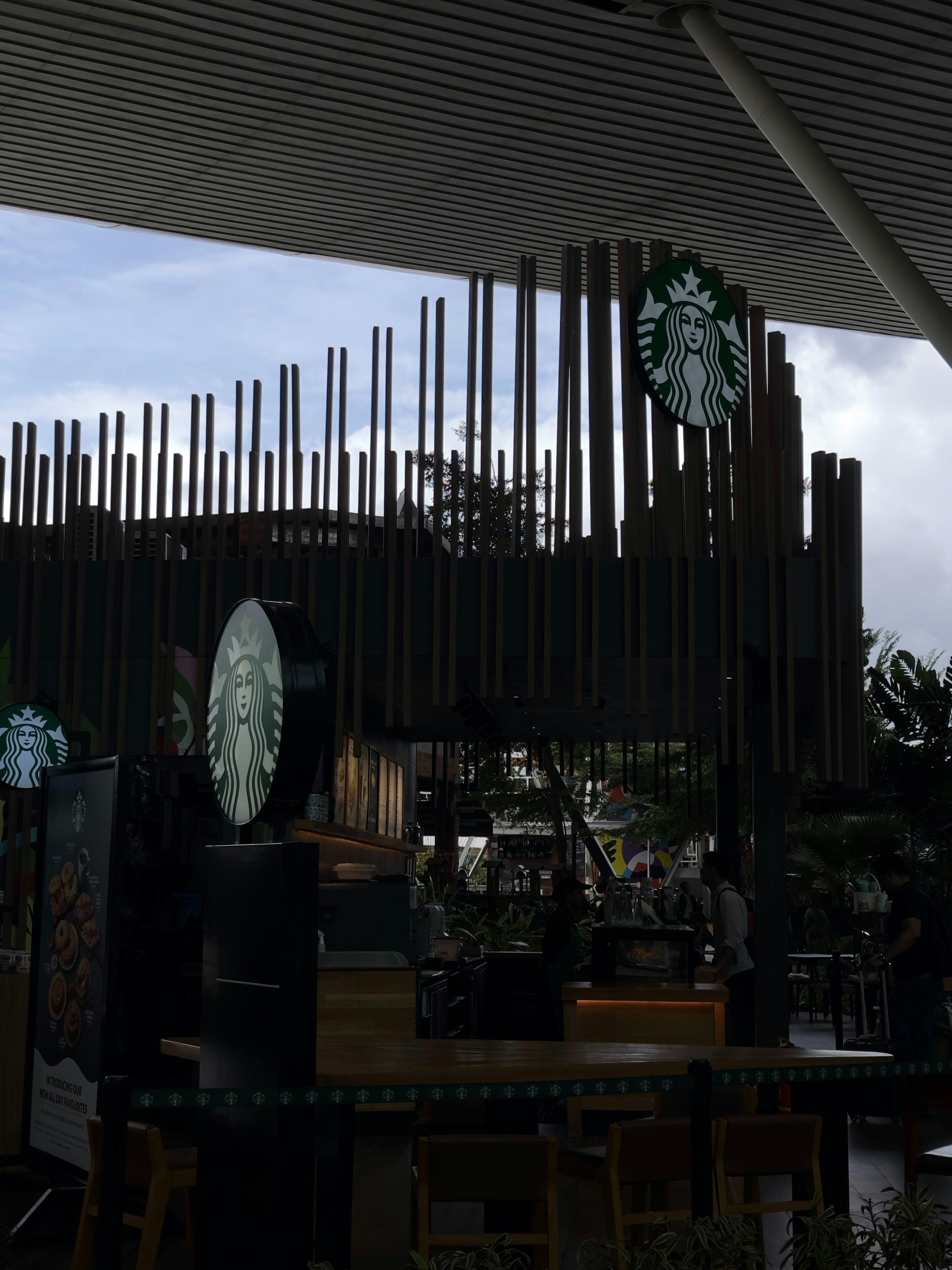 Timber Slats Framing a Quiet Starbucks Counter at Dusk