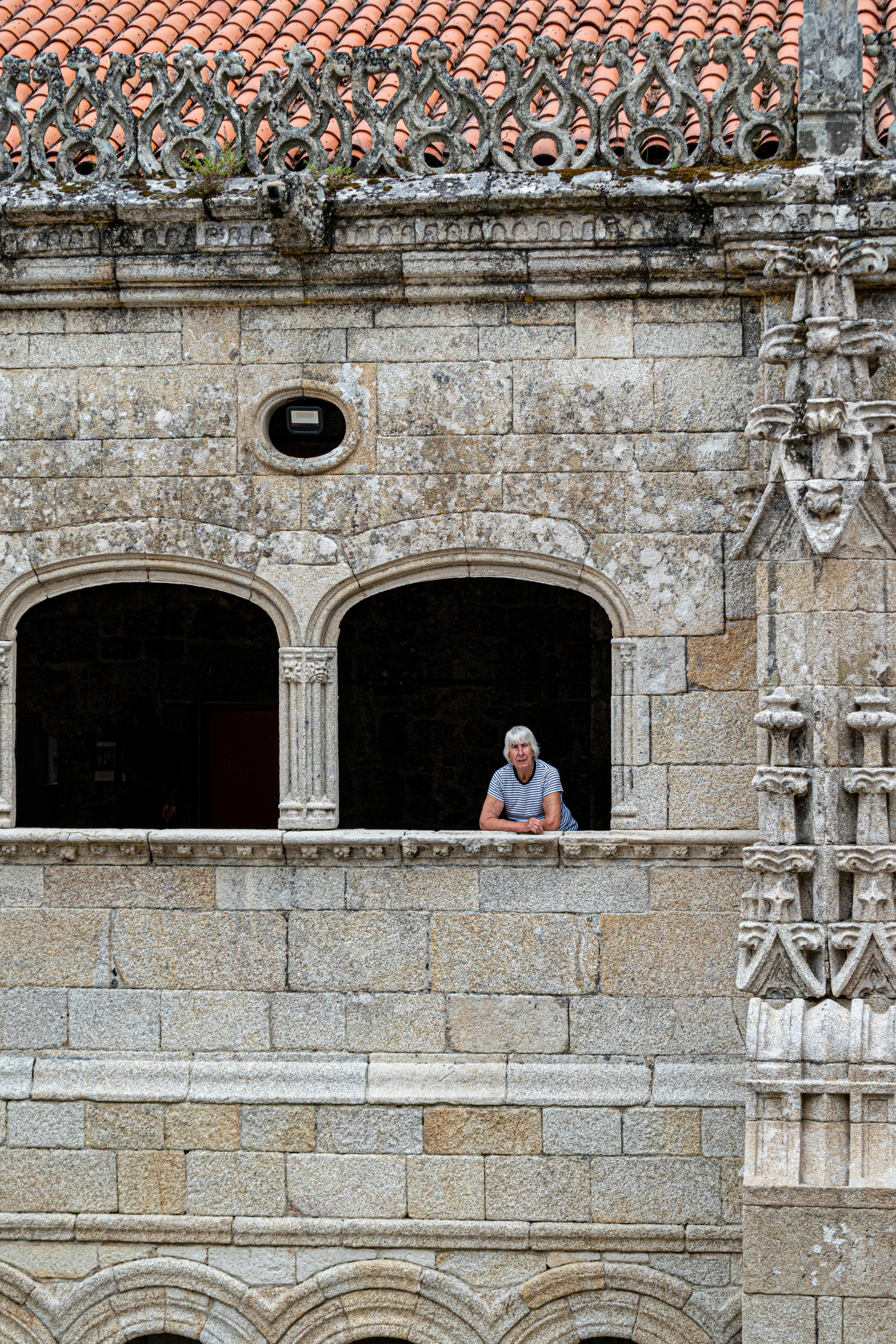 Balcony Observer: A Quiet Moment in Stonework