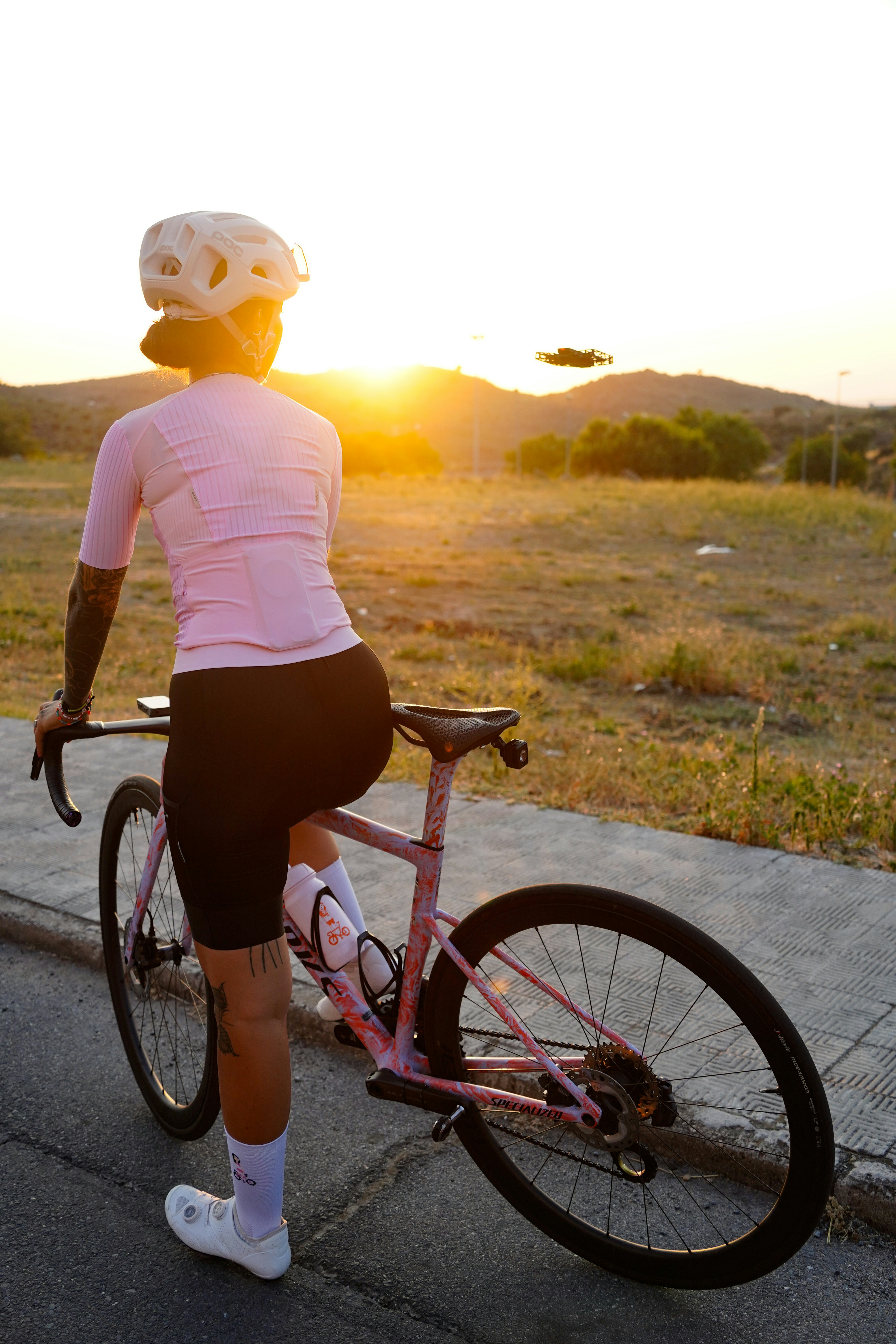 A woman riding a pink bike down a street photo – Free Shorts Image on ...