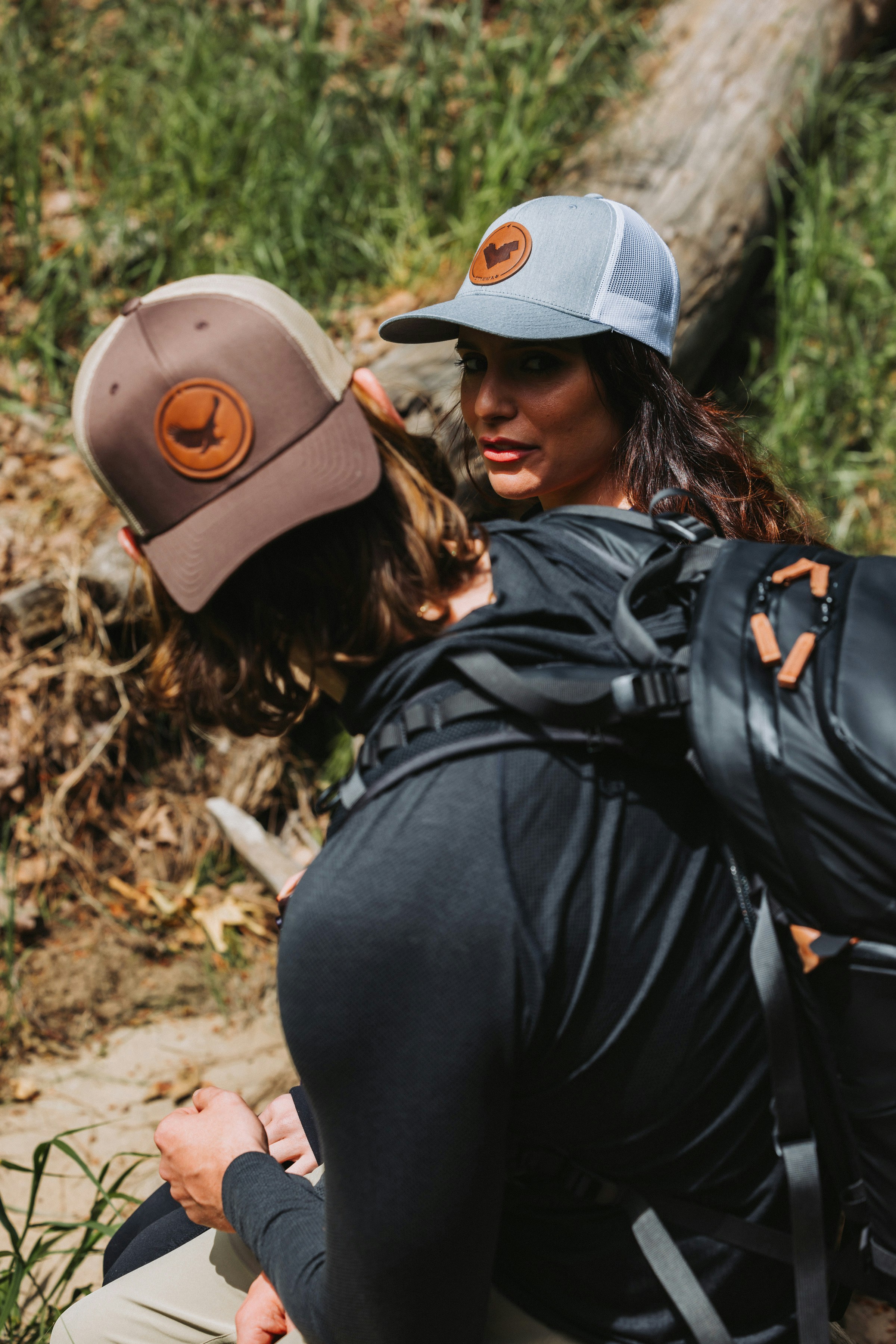 Photography by Ryan Hartford / Ecliptic Media Photography. Leather patch trucker hat being worn during a nature hike in the forest. The leather patch features an embossed American Eagle. Leather patch hat from Byward Outfitters www.bywardoutfitters.com