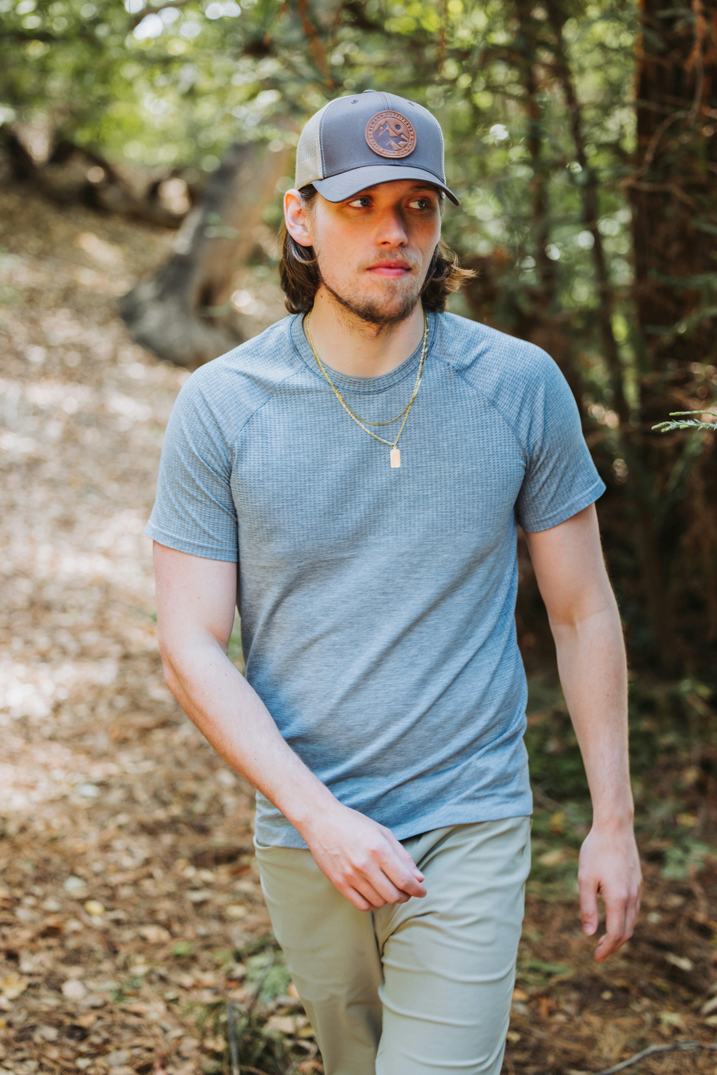 Photography by Ryan Hartford / Ecliptic Media Photography. Woman wearing our heat-pressed leather patch trucker hat in the forest during a nature hike. Leather patch hat from Byward Outfitters www.bywardoutfitters.com