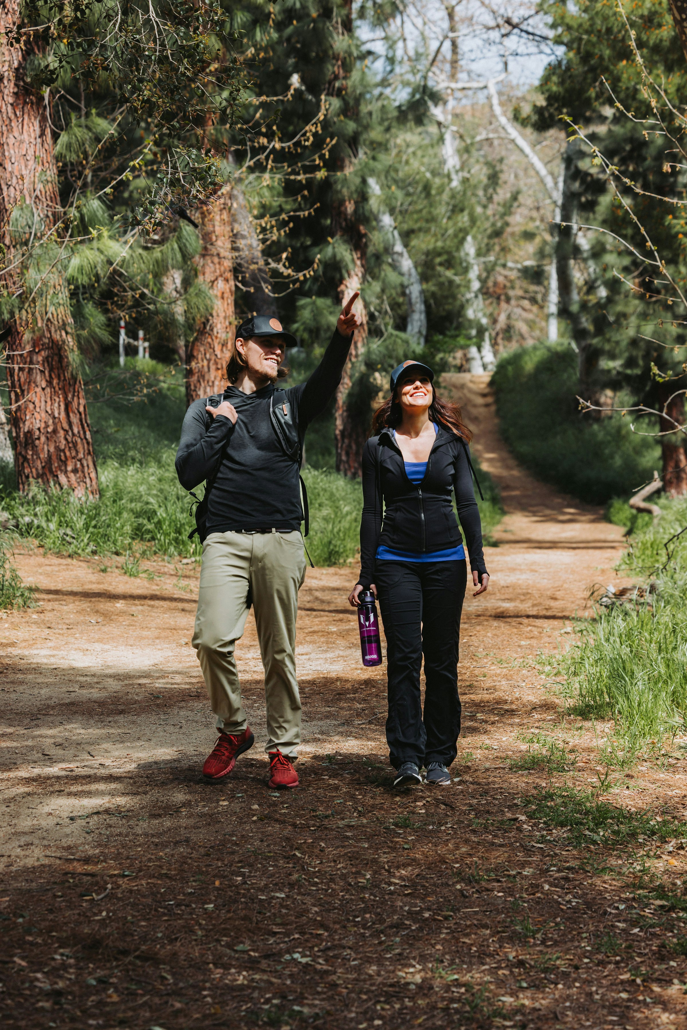 Photography by Ryan Hartford / Ecliptic Media Photography. Woman wearing our heat-pressed leather patch trucker hat in the forest during a nature hike. Leather patch hat from Byward Outfitters www.bywardoutfitters.com