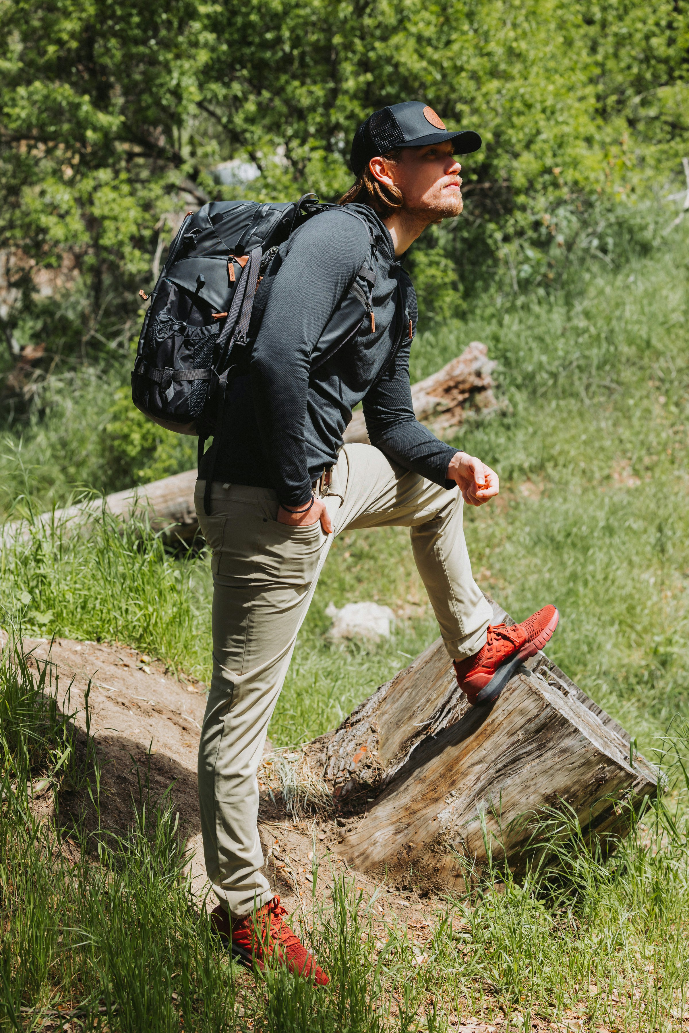 Photography by Ryan Hartford / Ecliptic Media Photography. Woman wearing our heat-pressed leather patch trucker hat in the forest during a nature hike. Leather patch hat from Byward Outfitters www.bywardoutfitters.com