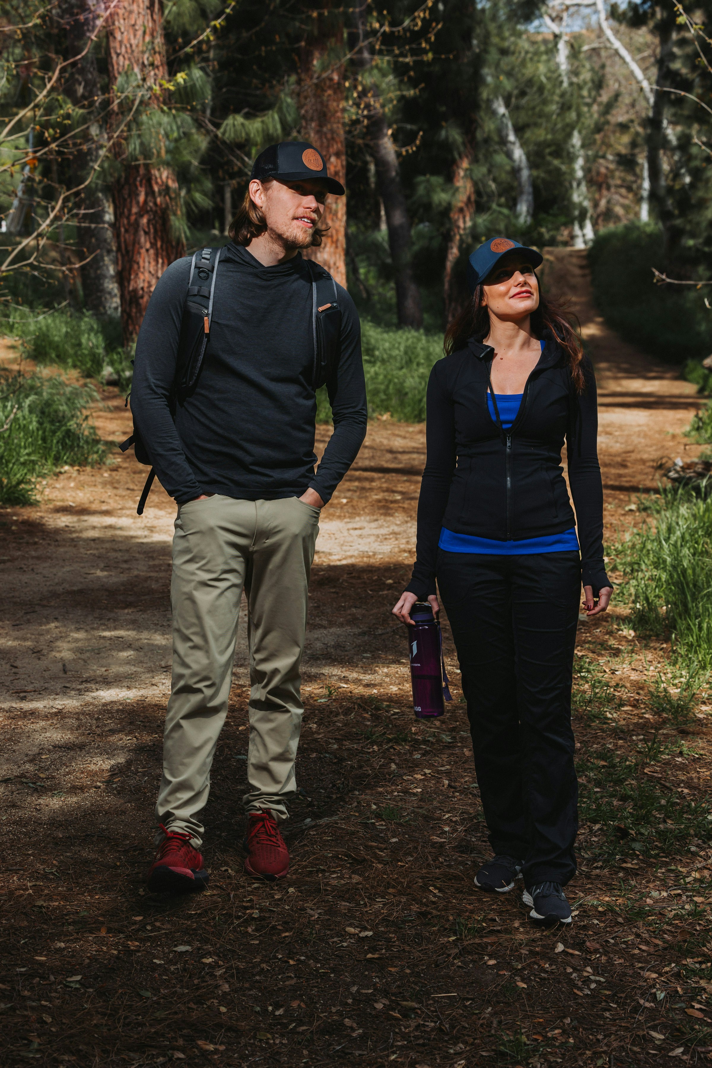 Photography by Ryan Hartford / Ecliptic Media Photography. Woman wearing our heat-pressed leather patch trucker hat in the forest during a nature hike. Leather patch hat from Byward Outfitters www.bywardoutfitters.com