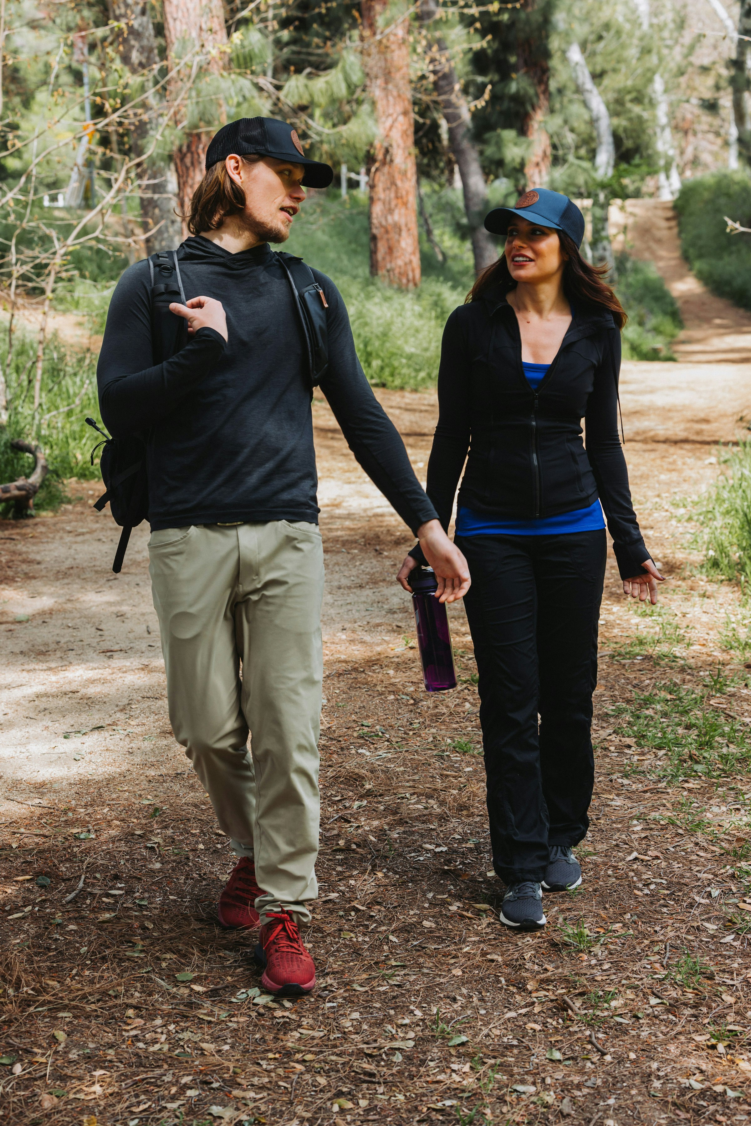 Photography by Ryan Hartford / Ecliptic Media Photography. Woman wearing our heat-pressed leather patch trucker hat in the forest during a nature hike. Leather patch hat from Byward Outfitters www.bywardoutfitters.com