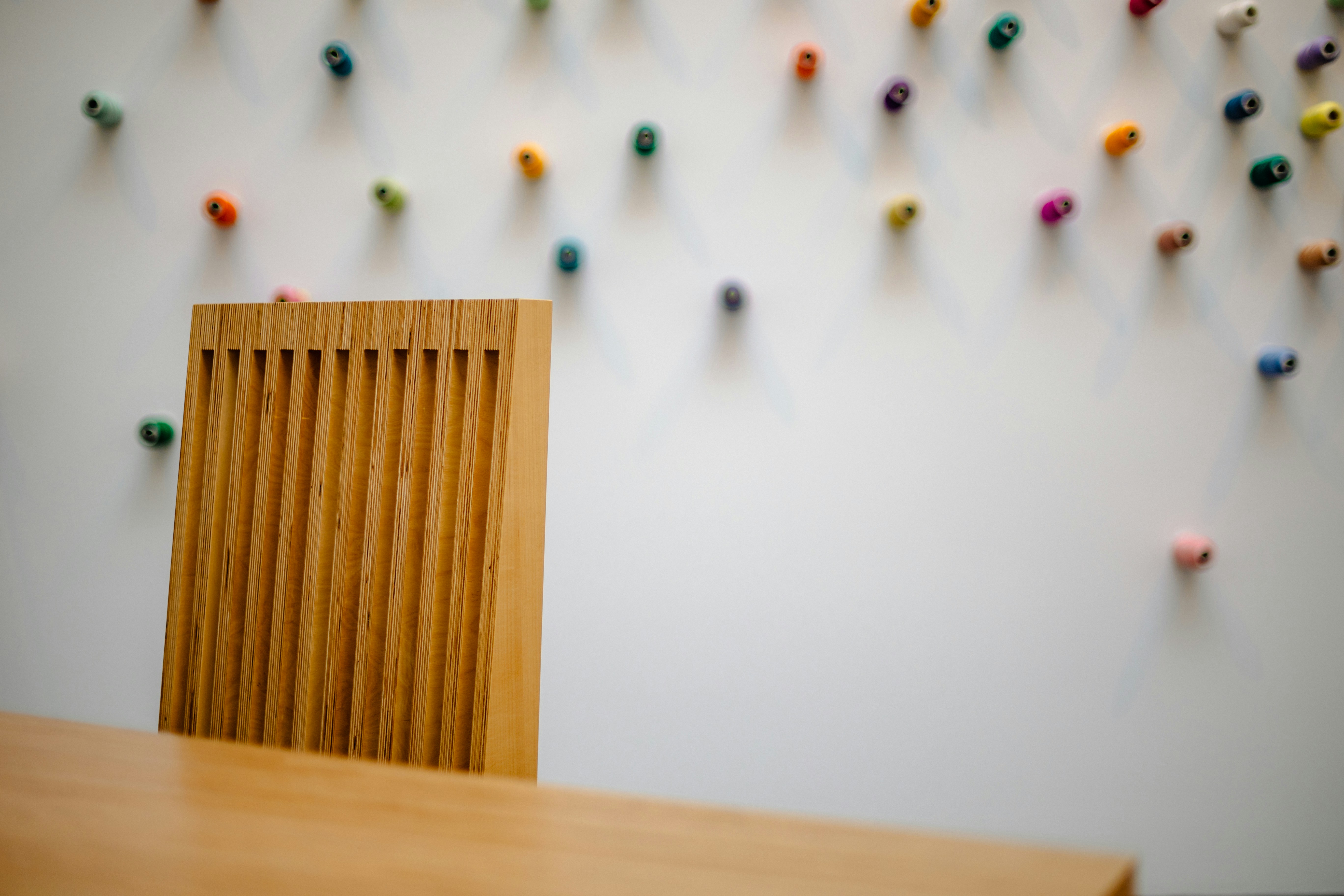 Minimal chair, quiet conference room with a wall of colorful pins