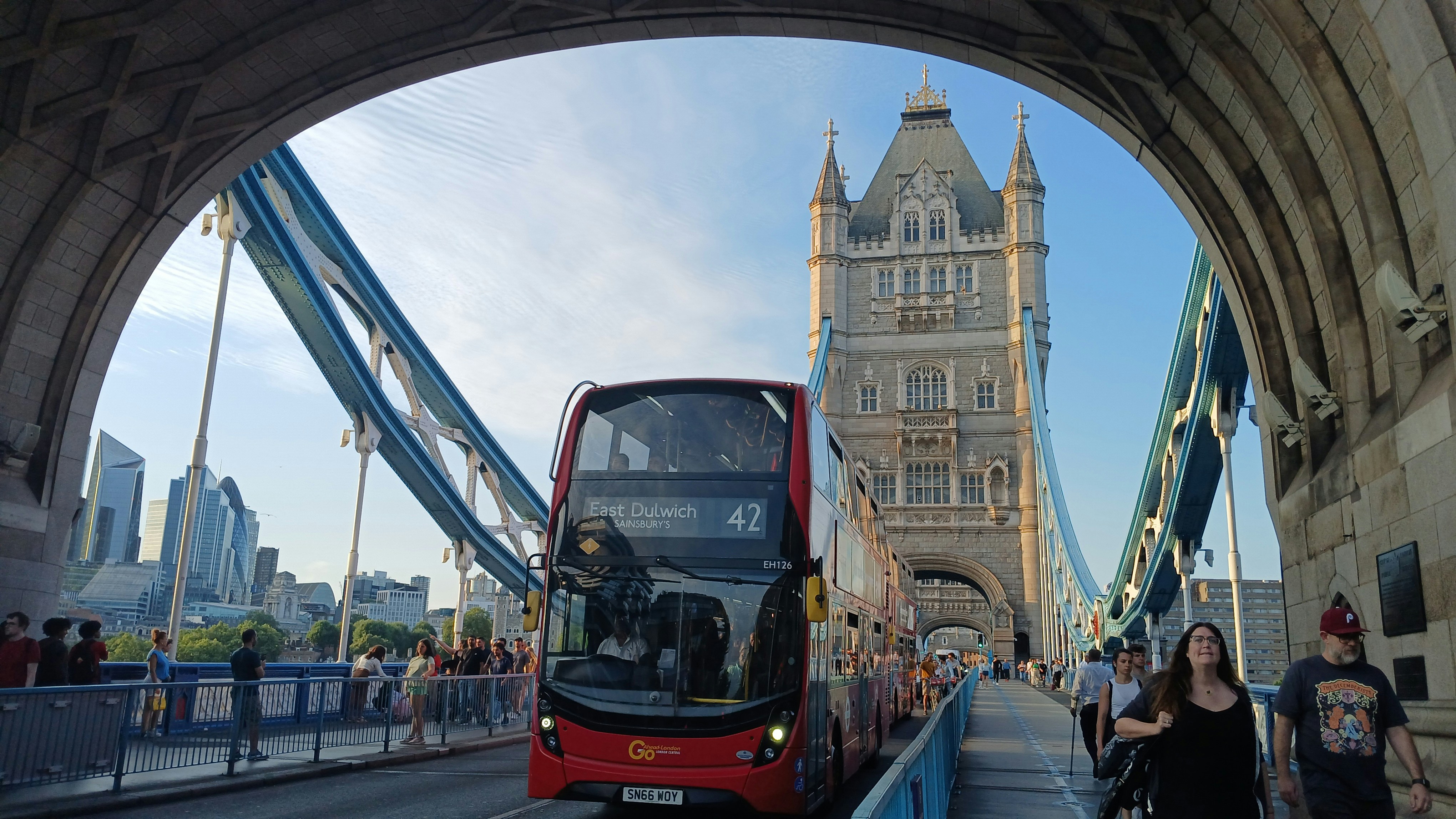 Red Metro in Focus: Tower Bridge Framed by the Shimmering South Bank