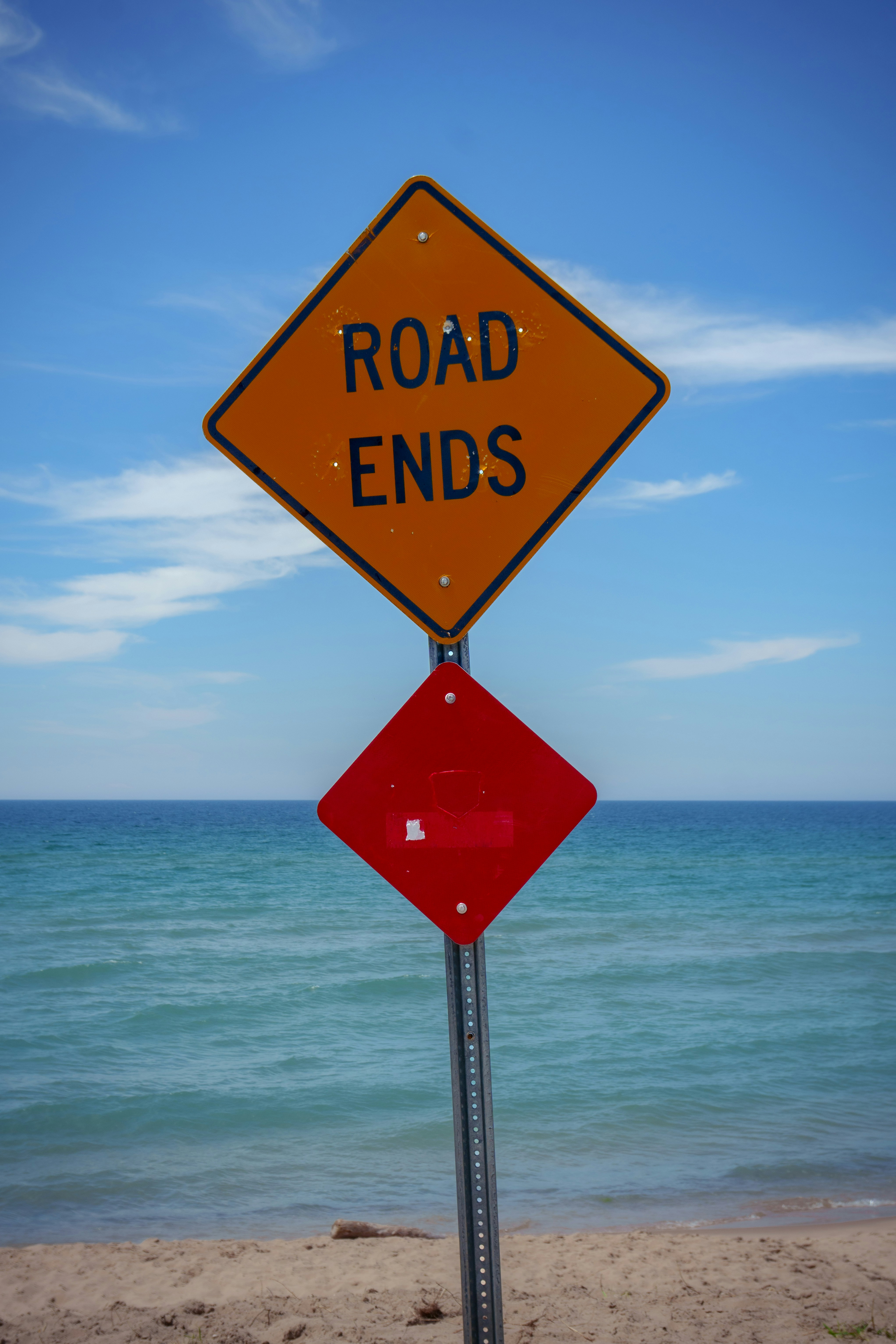 A road ends sign on a beach with the ocean in the background photo ...