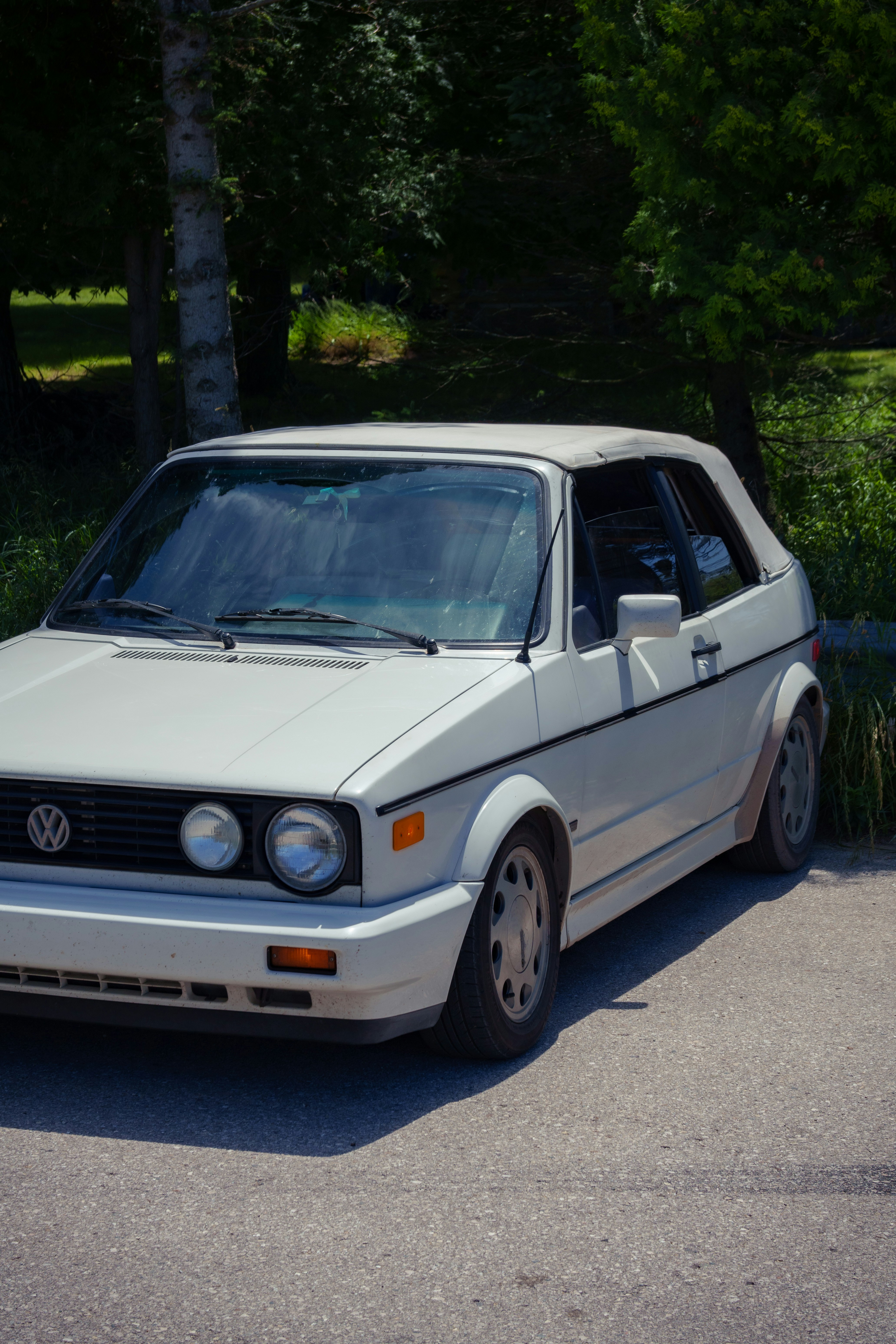 Forest-Edge Classic: White VW Golf Mk2 Resting on a Sunlit Road