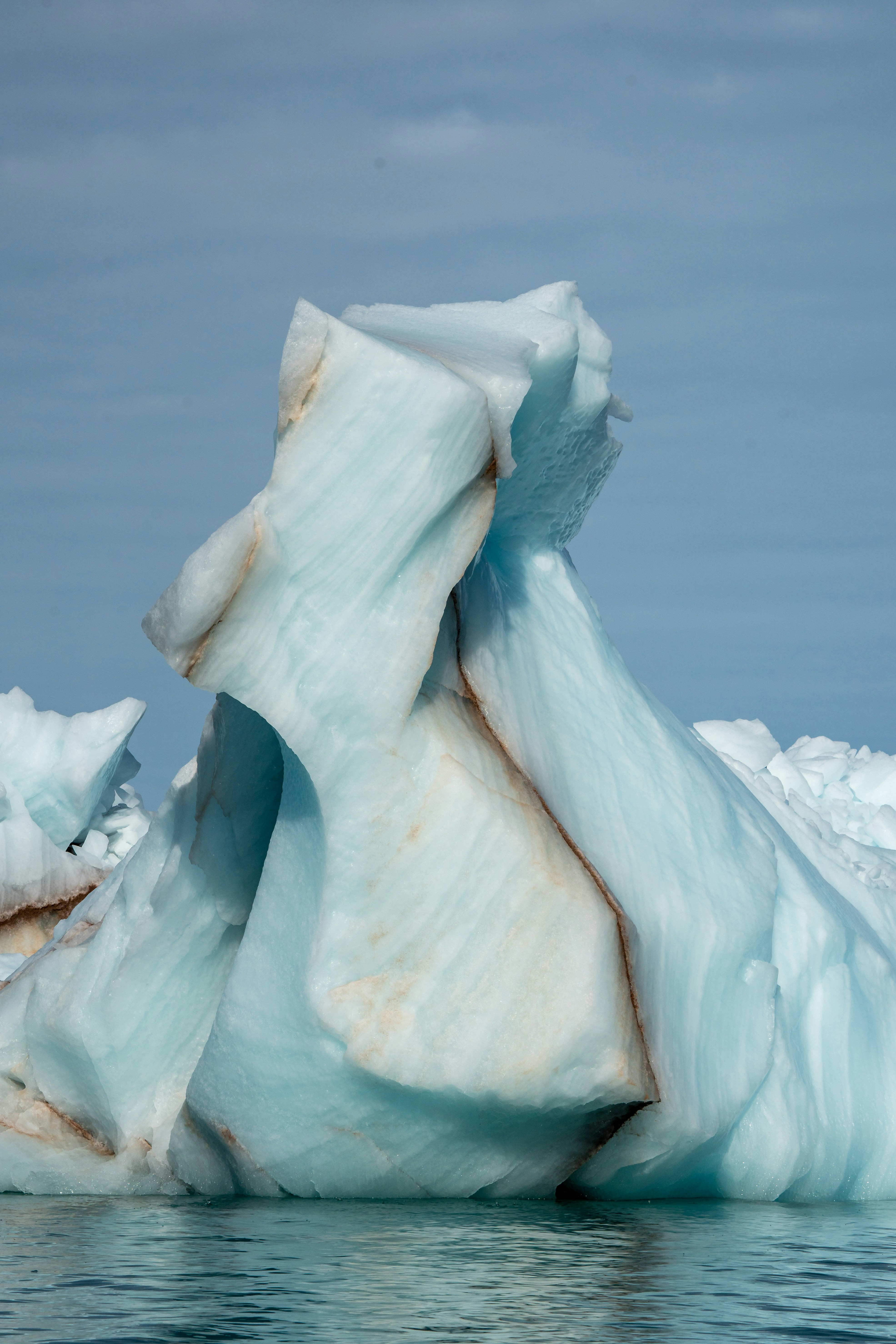 Azure Ice Monolith Rising from a Calm Polar Sea