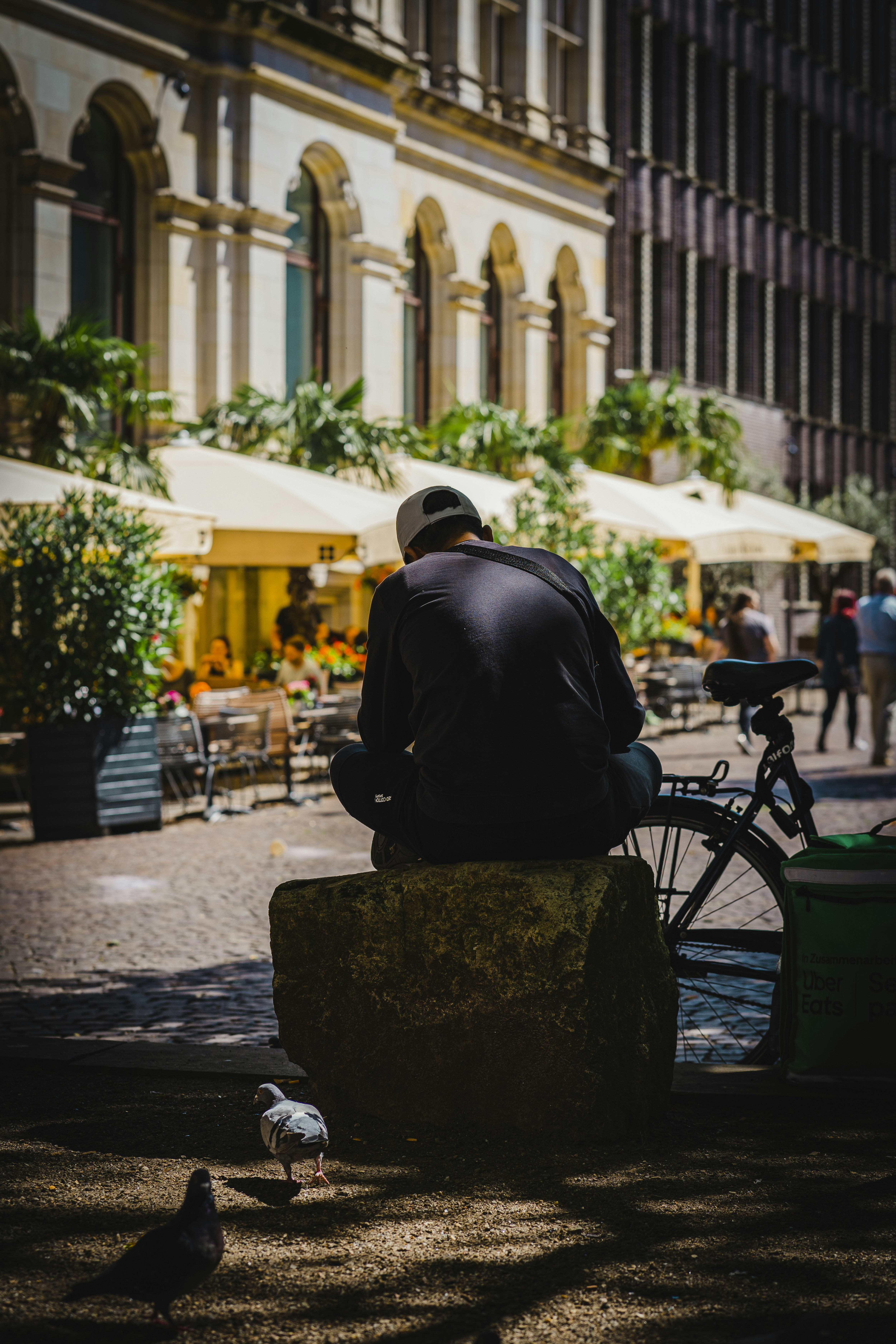 Seat of Stillness: A Solitary Figure Beneath Urban Arches