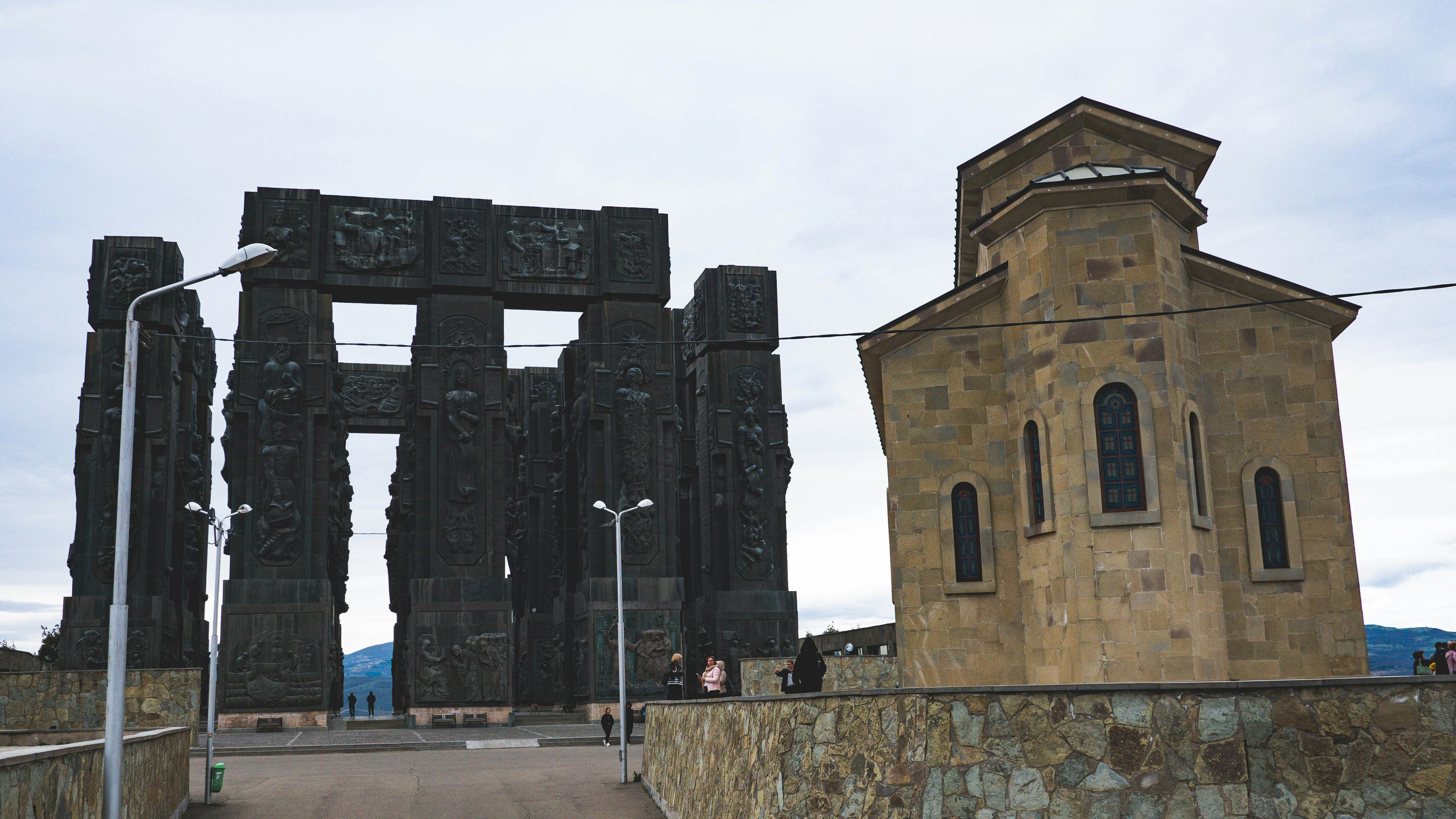 Monolithic Gate on the Plateau: Carved Columns Framing a Quiet Horizon