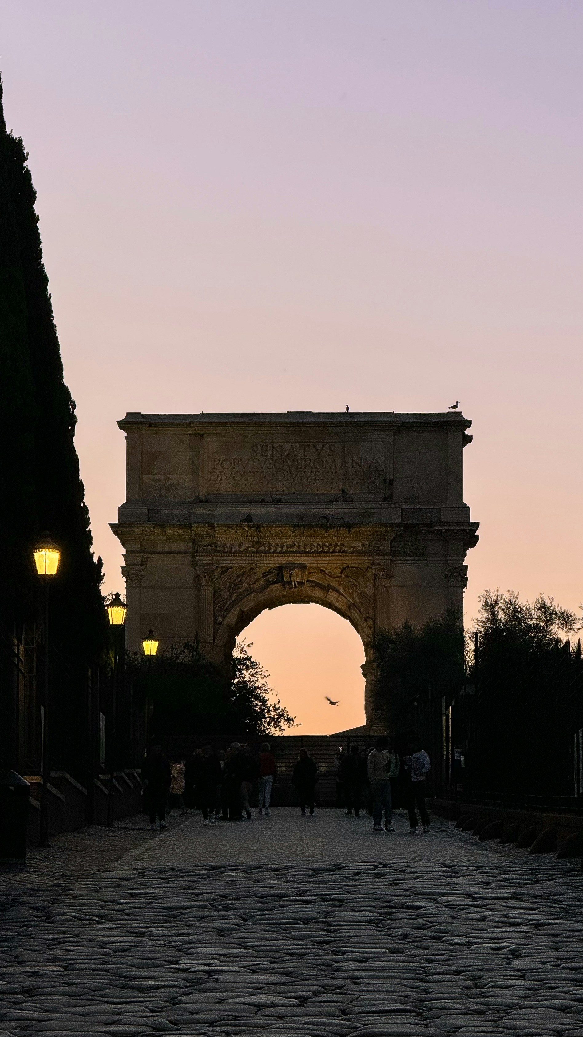 Twilight Archway: Lantern-lit Cobblestones Toward a Sunset Gateway