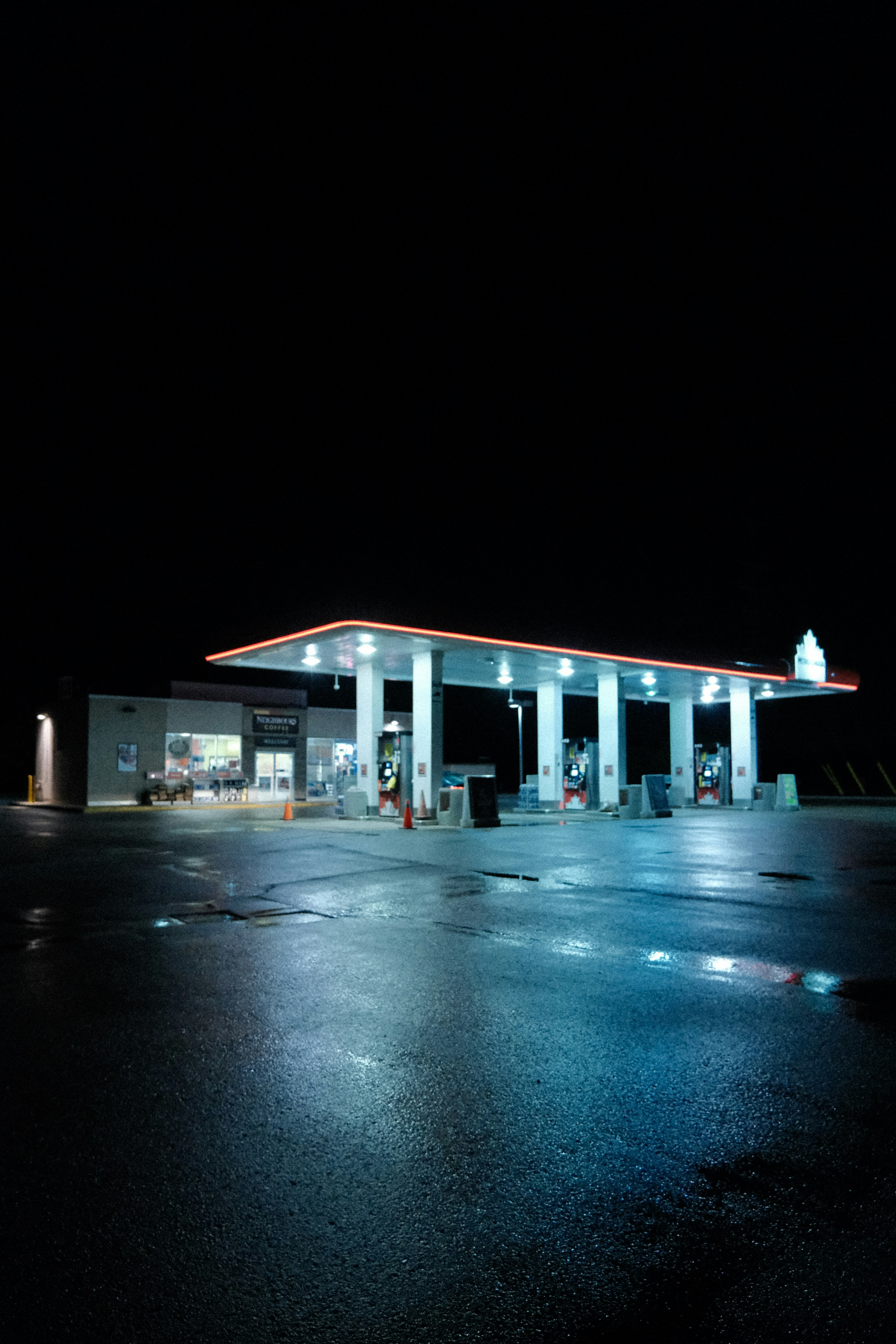 A gas station lit up at night time photo – Free Night Image on Unsplash