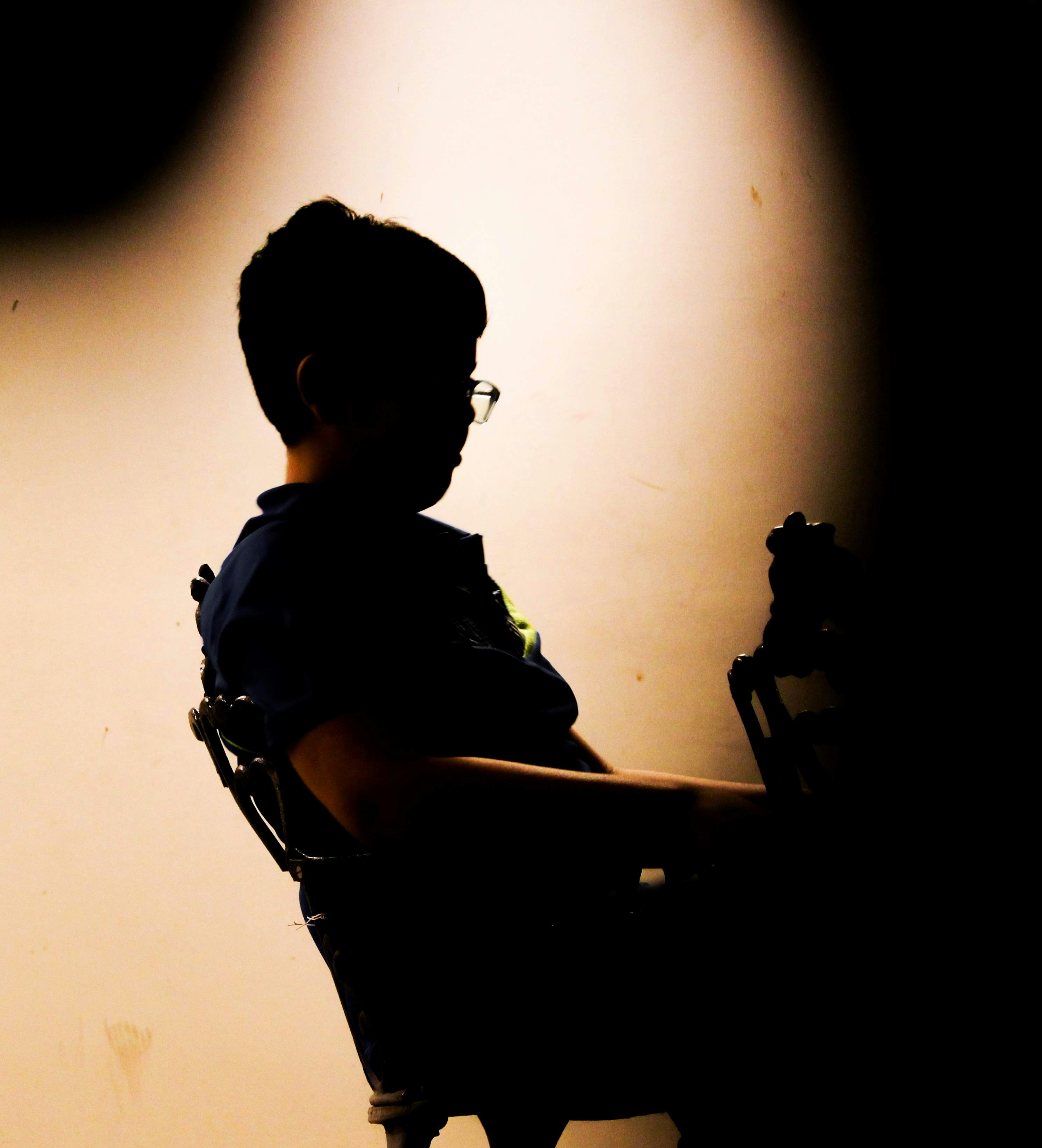 Under the Spotlight: A Quiet Silhouette in Backlit Studio