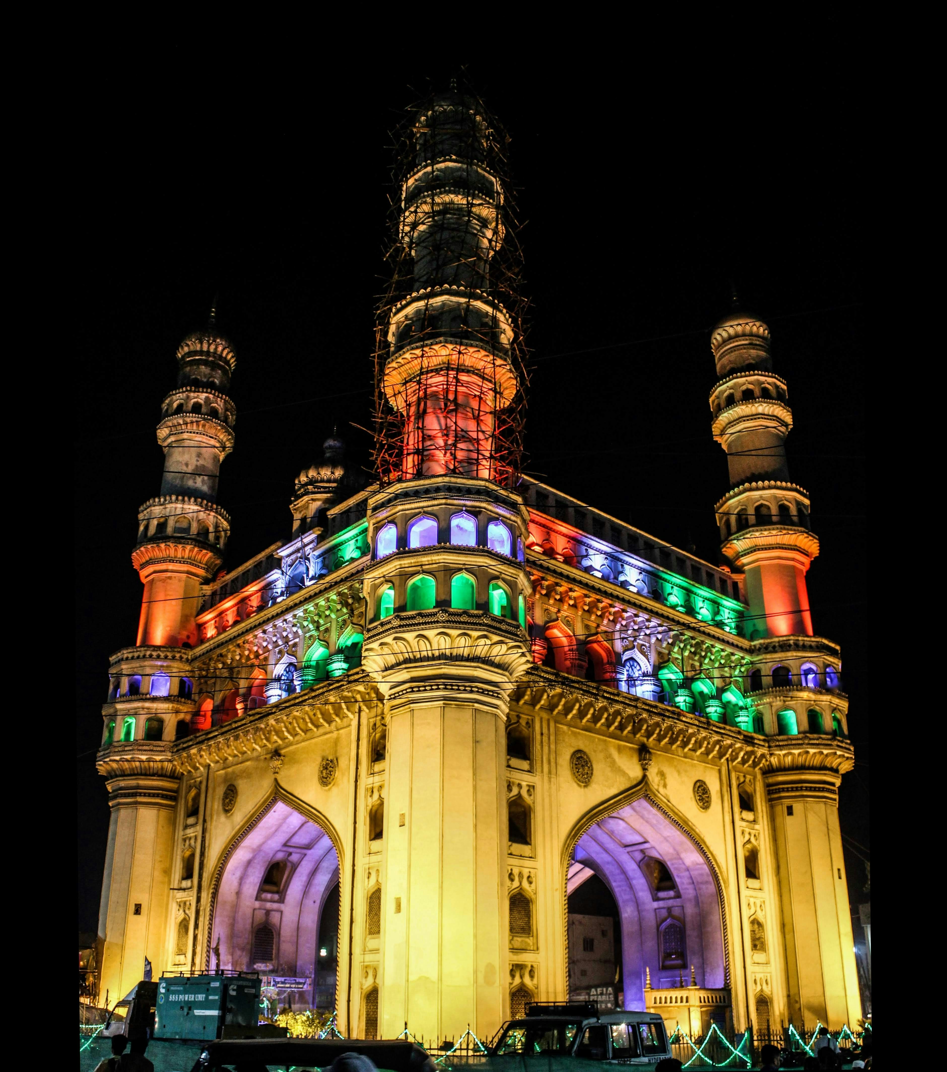 The iconic monument is adorned with vibrant lights, showcasing its intricate architectural details against the night sky.
