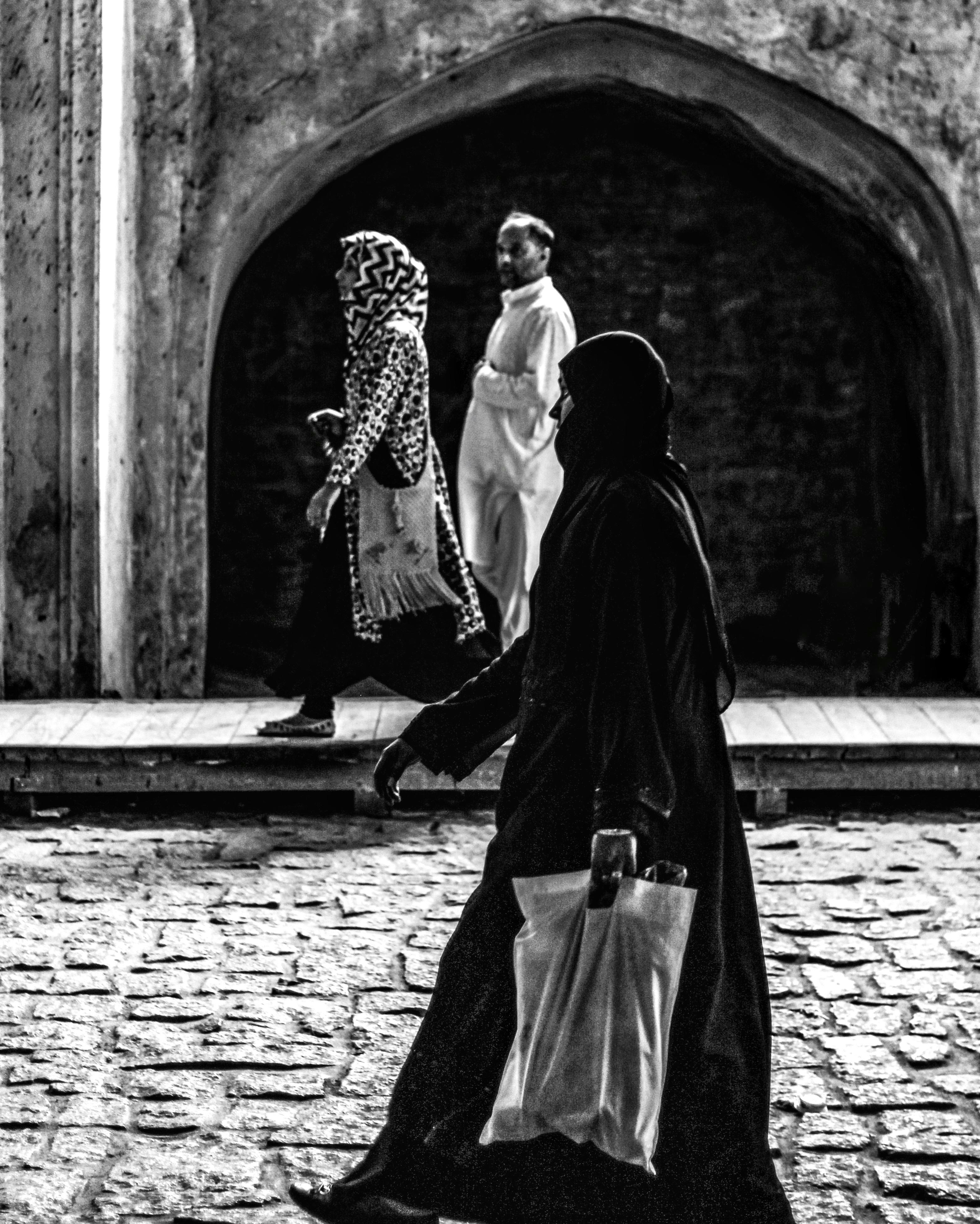 Silhouette in the Arch: A Monochrome Crossing