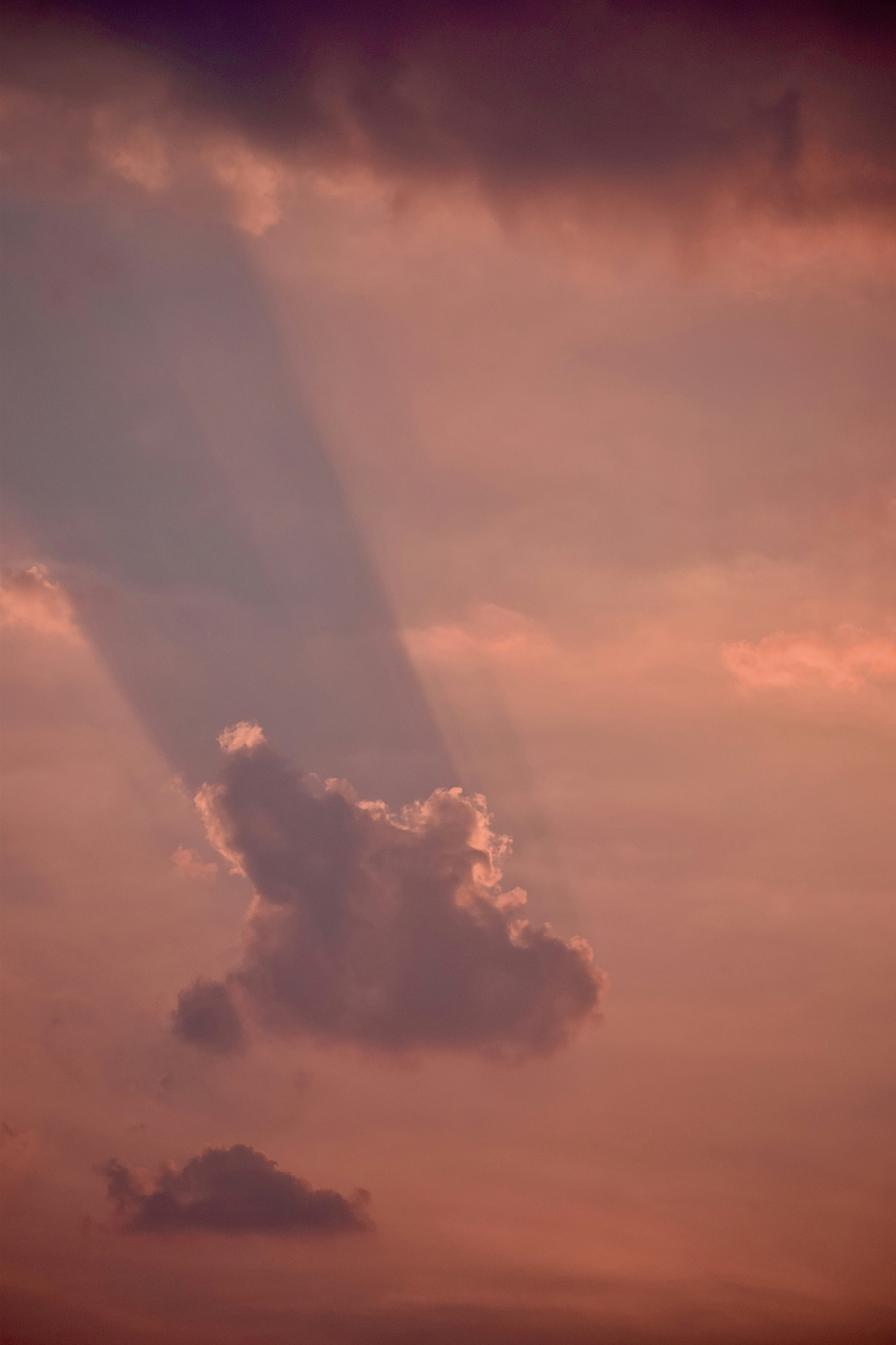 Dusk’s Quiet Cathedral: Crepuscular Rays Through a Pink Cloud