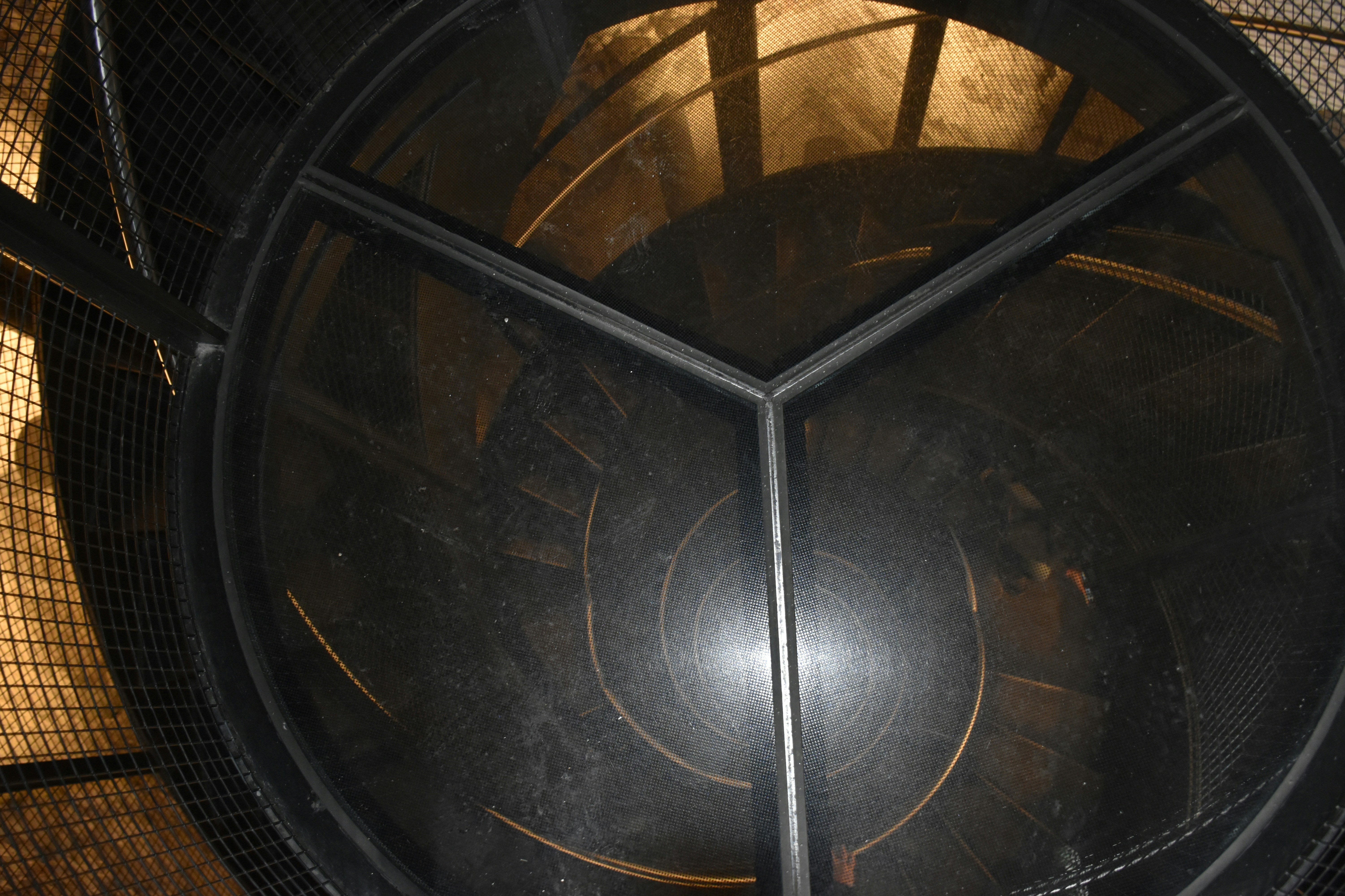 A large metal object with a wire cage around it photo – Free Machine ...