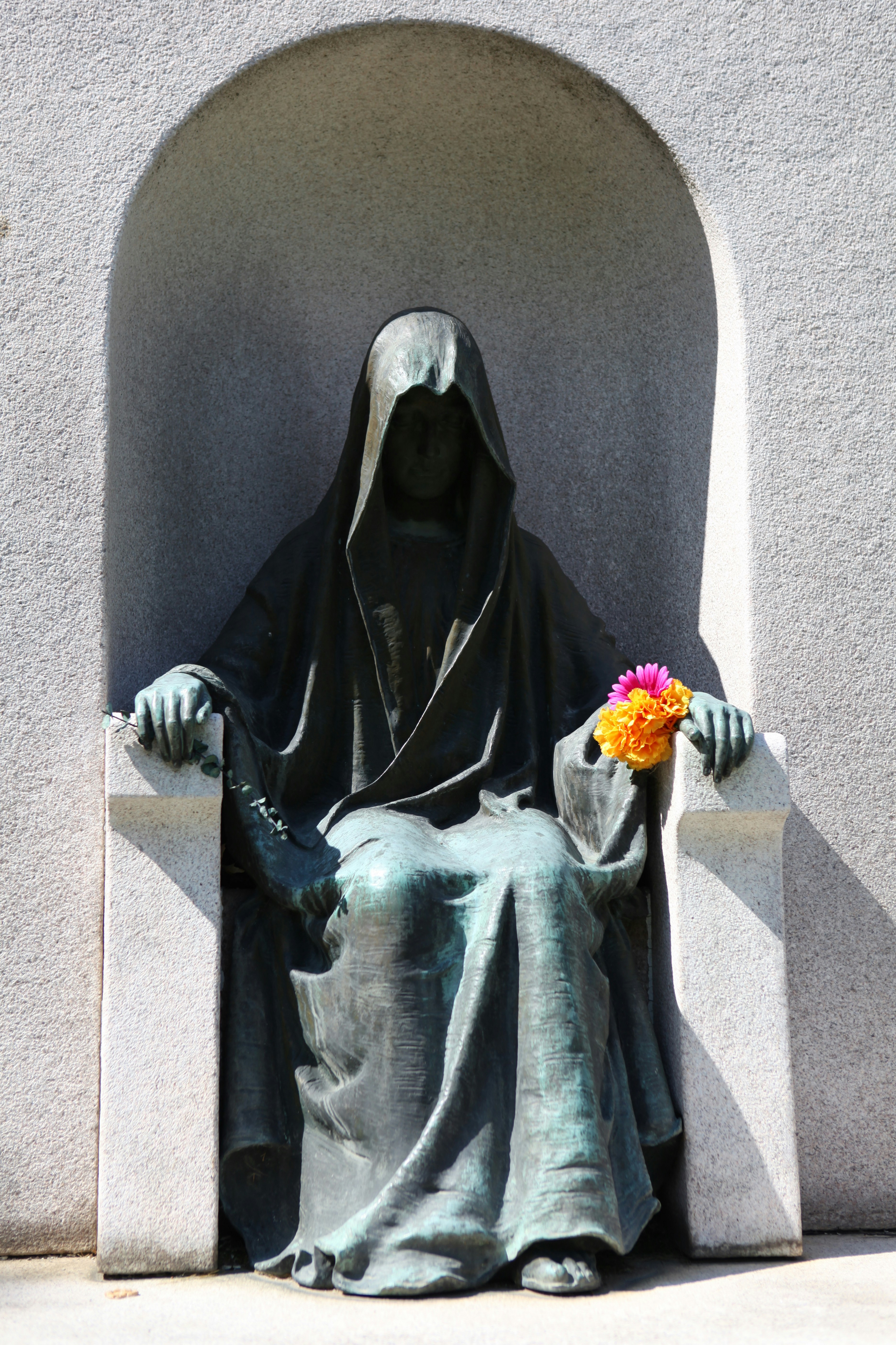 Memento in the Archway: A Hooded Figure with a Burst of Color