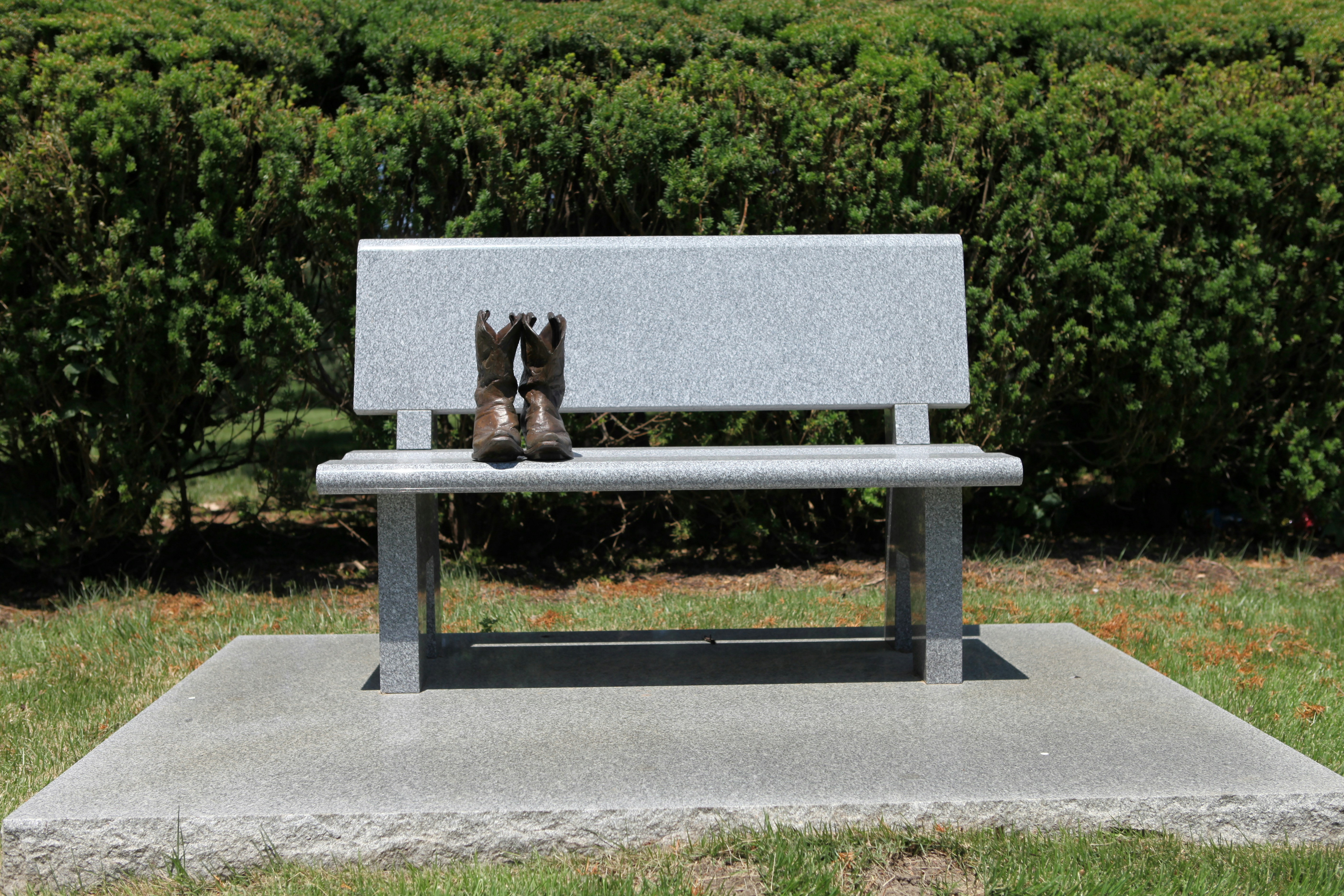 Boots on a Park Bench: Quiet Repose in the Sunlit Field
