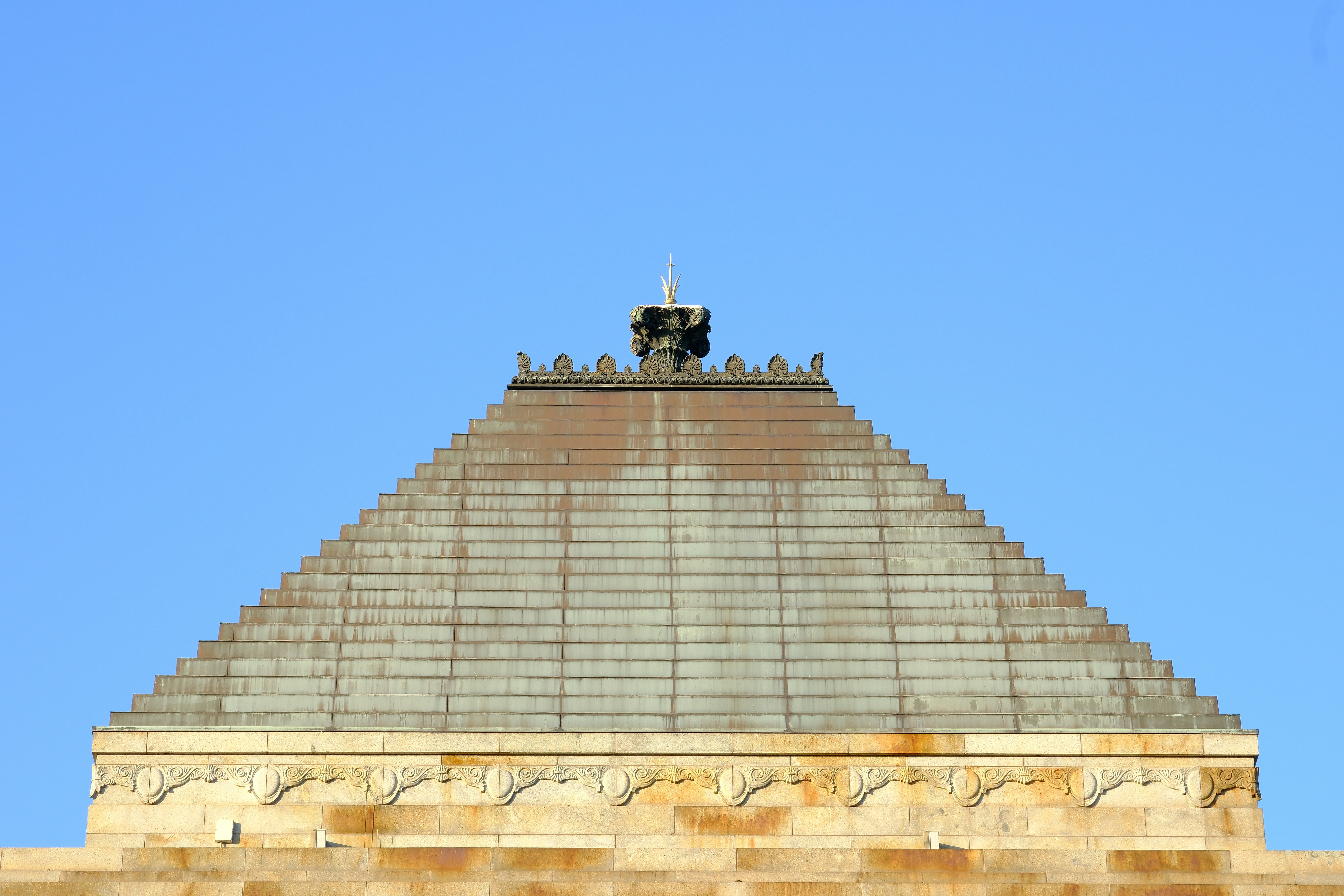 Apex Crown: Stone Pyramid Reaches Toward a Clear Sky