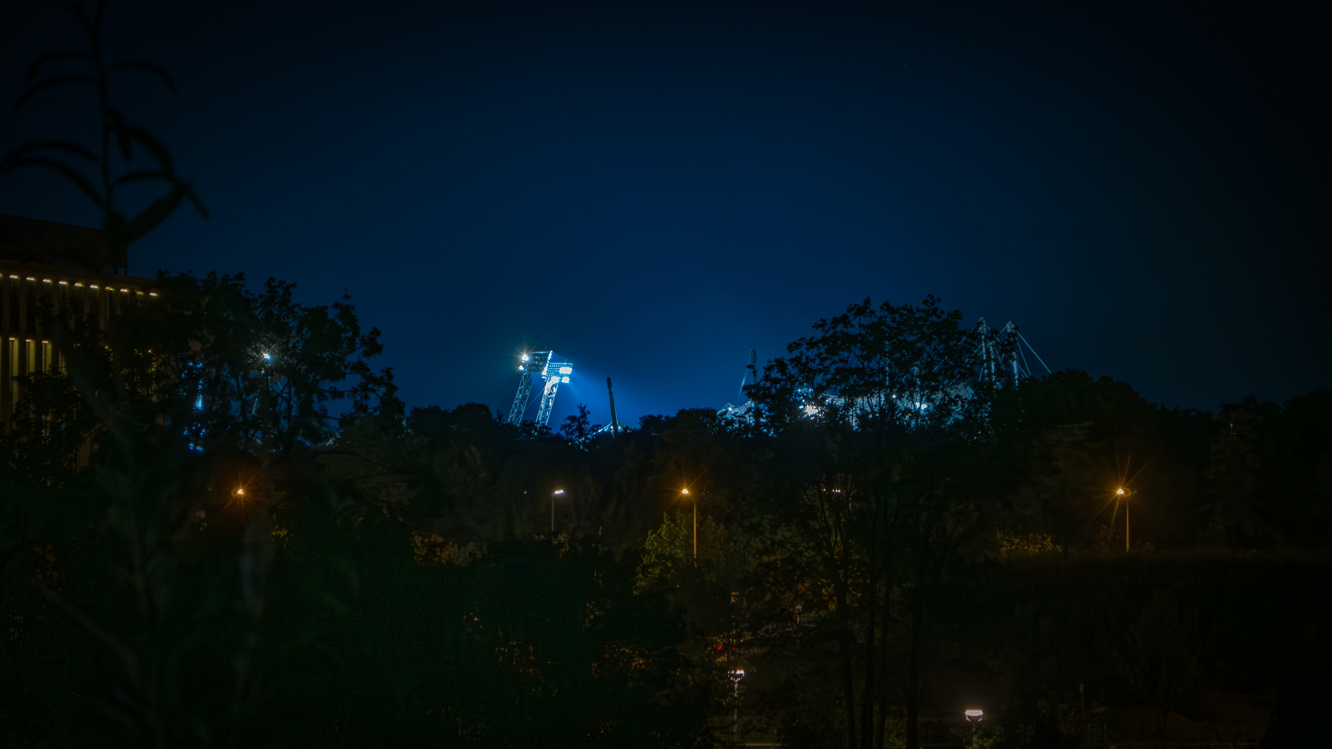Blue Skyline Above a Quiet Riverside Park at Night