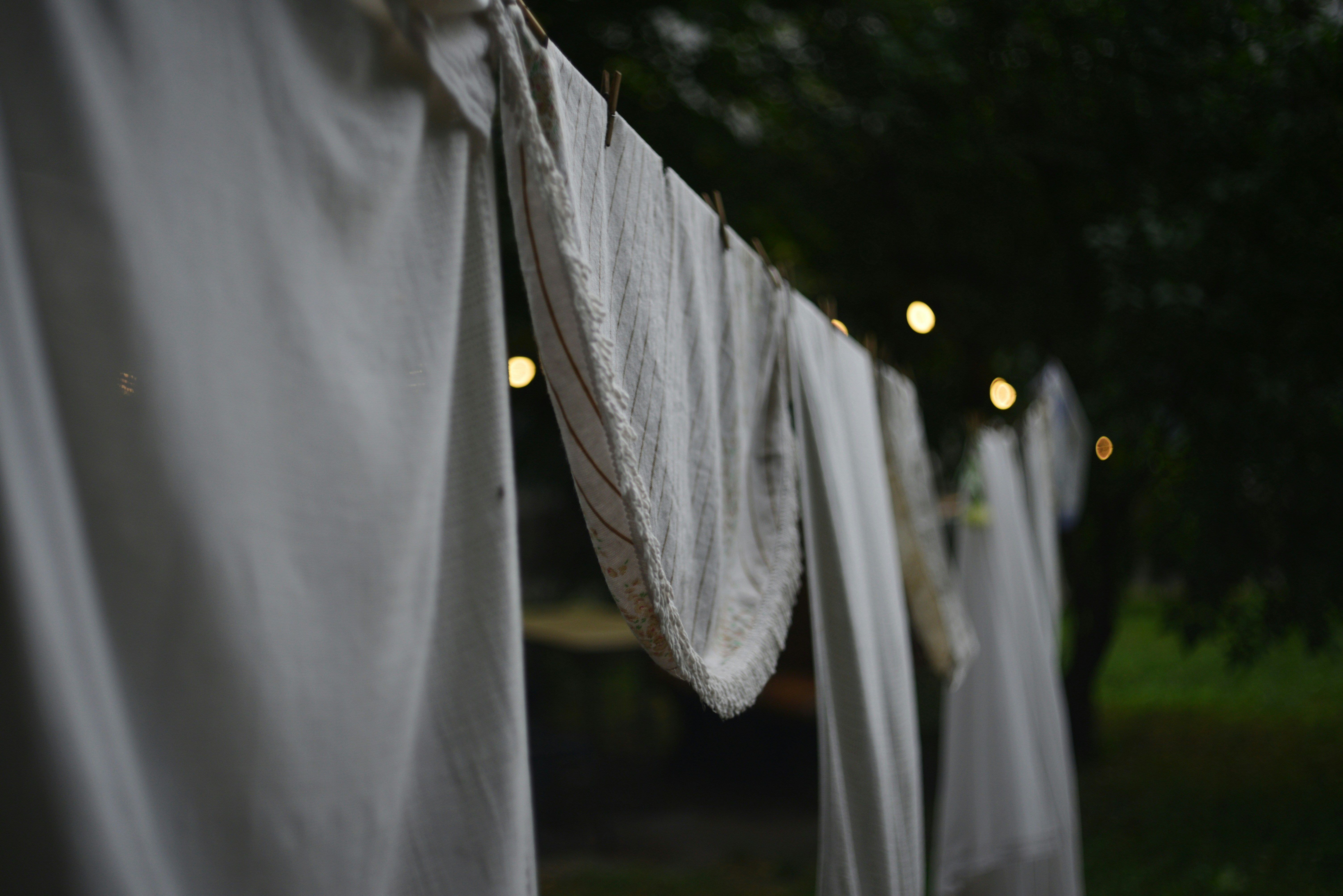 A line of drapes with lights hanging from them photo – Free Woman Image ...