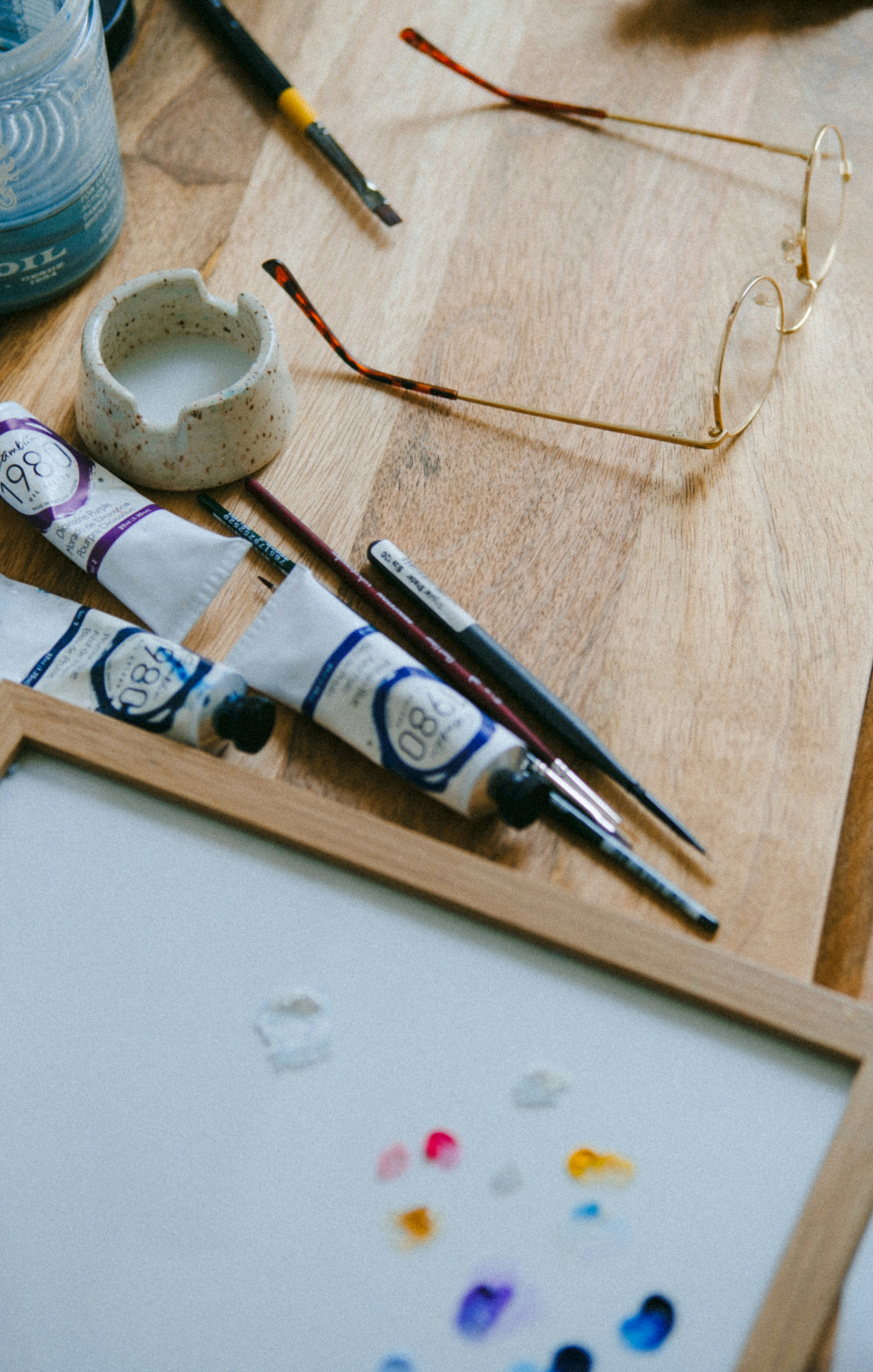 A wooden table topped with lots of art supplies photo – Free ...