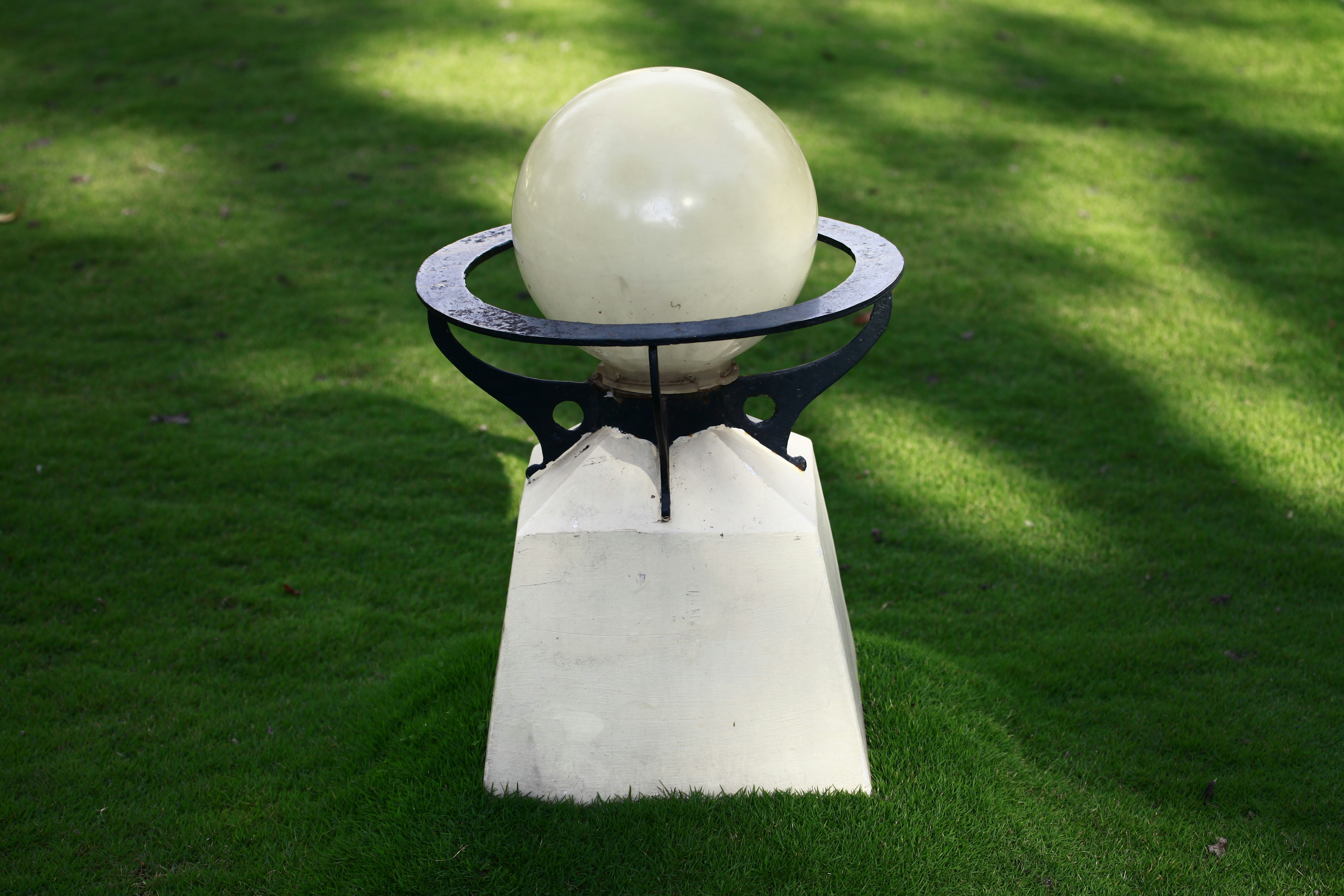 Orb on a Ring: Minimalist Globe Sculpture in Green Park