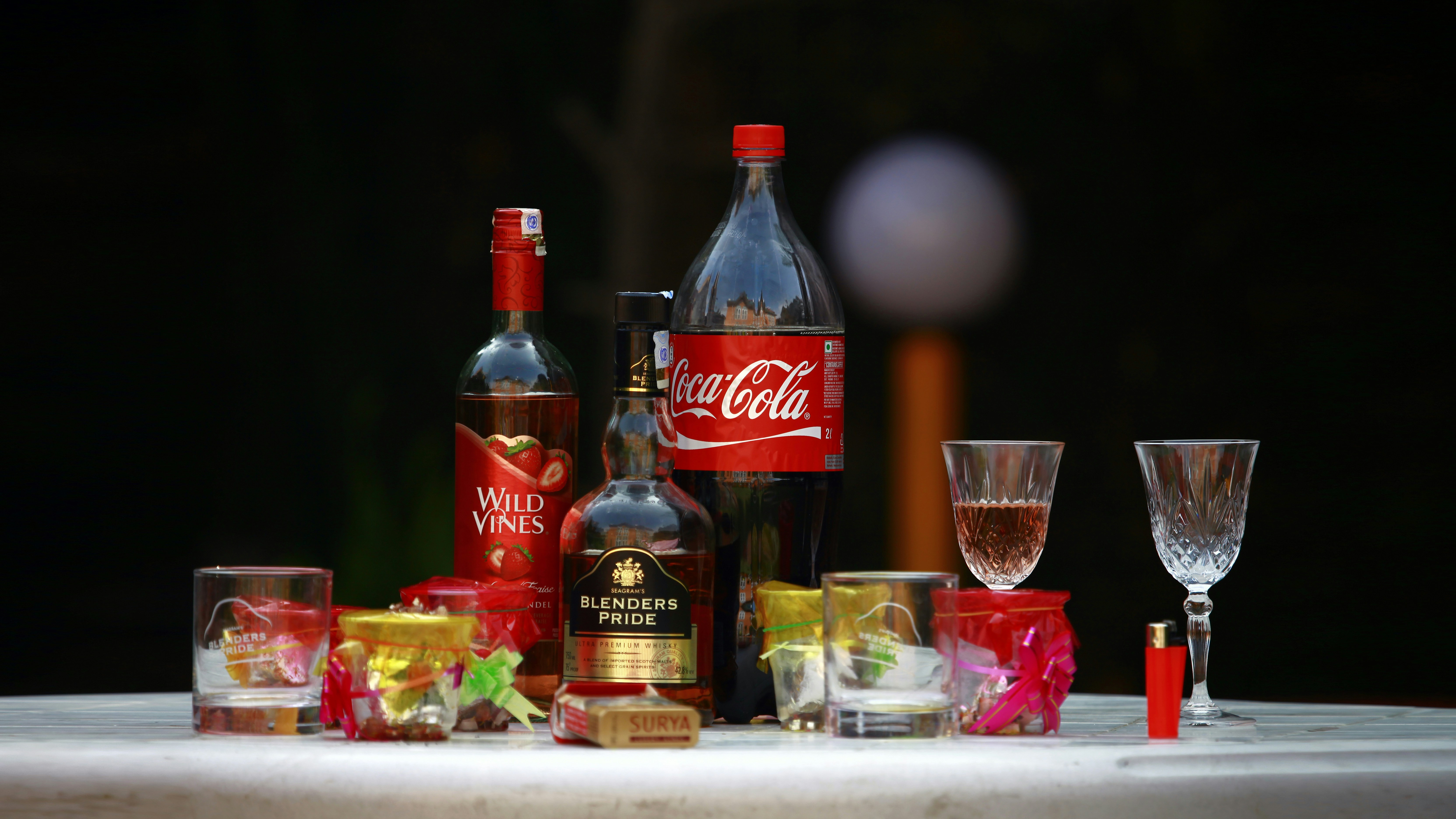 Tabletop Libations: An Arranged still-life of Soft-glow Bottles and Glassware