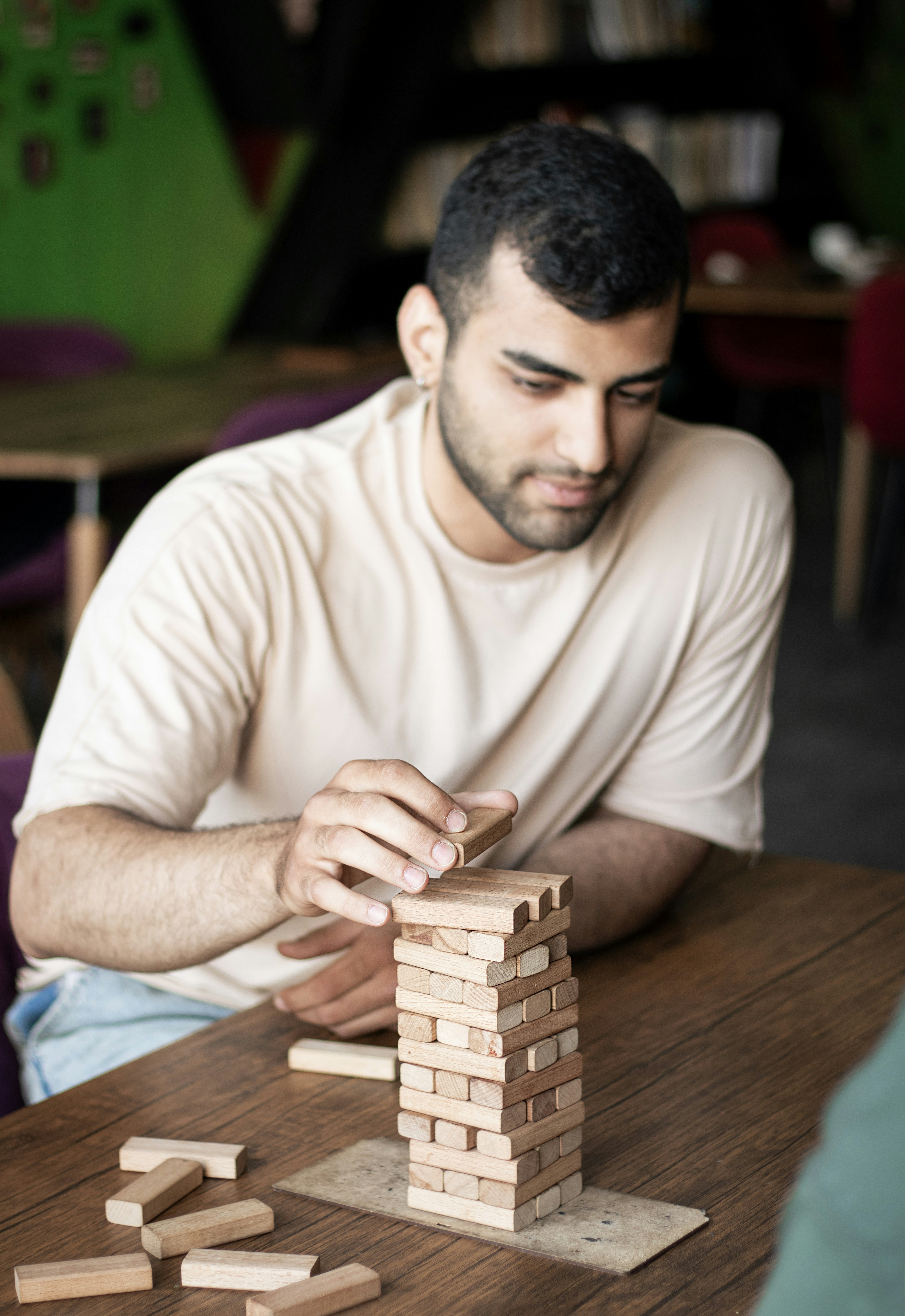 Hands in Focus: a casual tower of wooden blocks takes shape