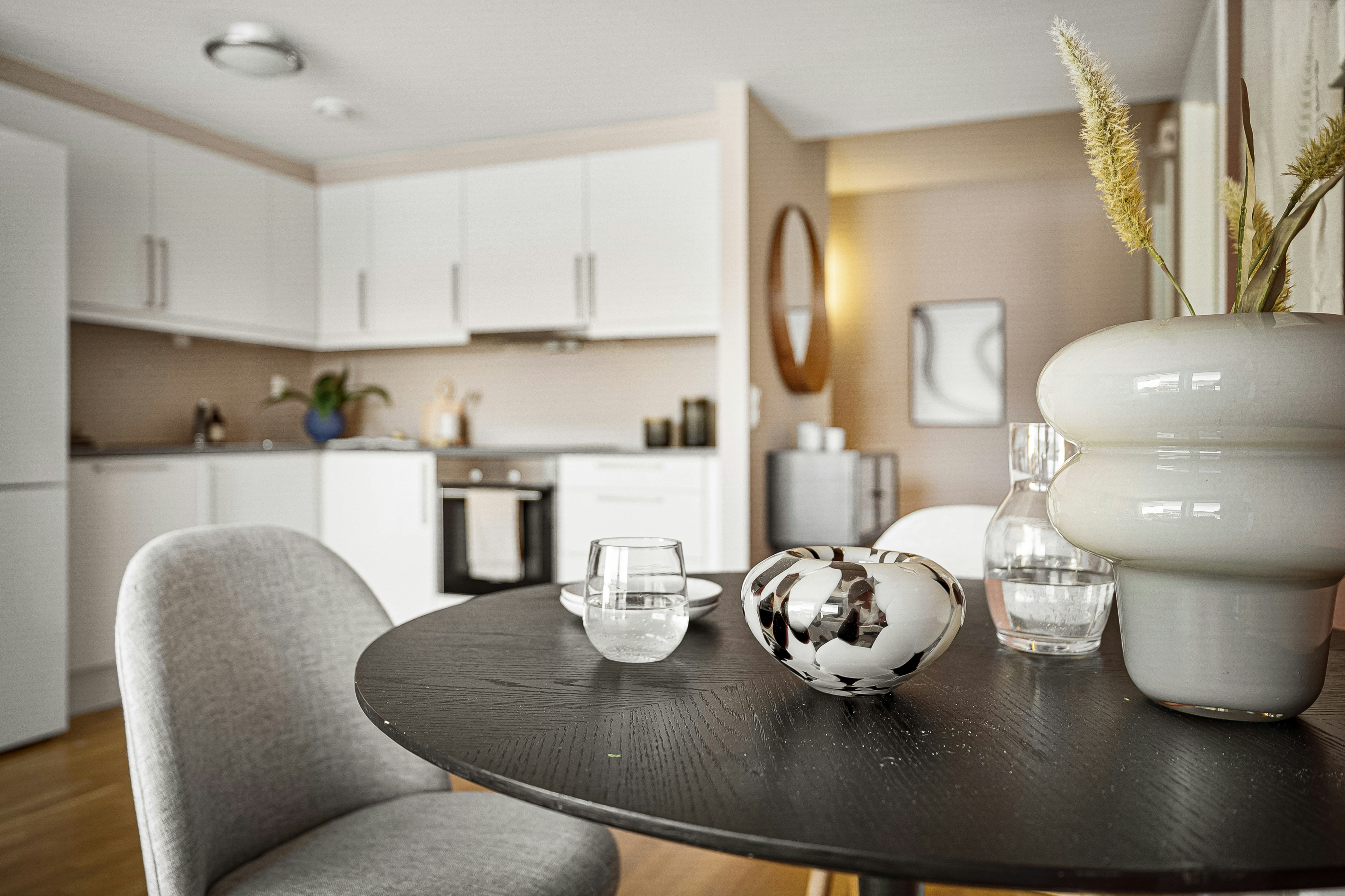 A dining room table with chairs and a vase on top of it photo – Free ...