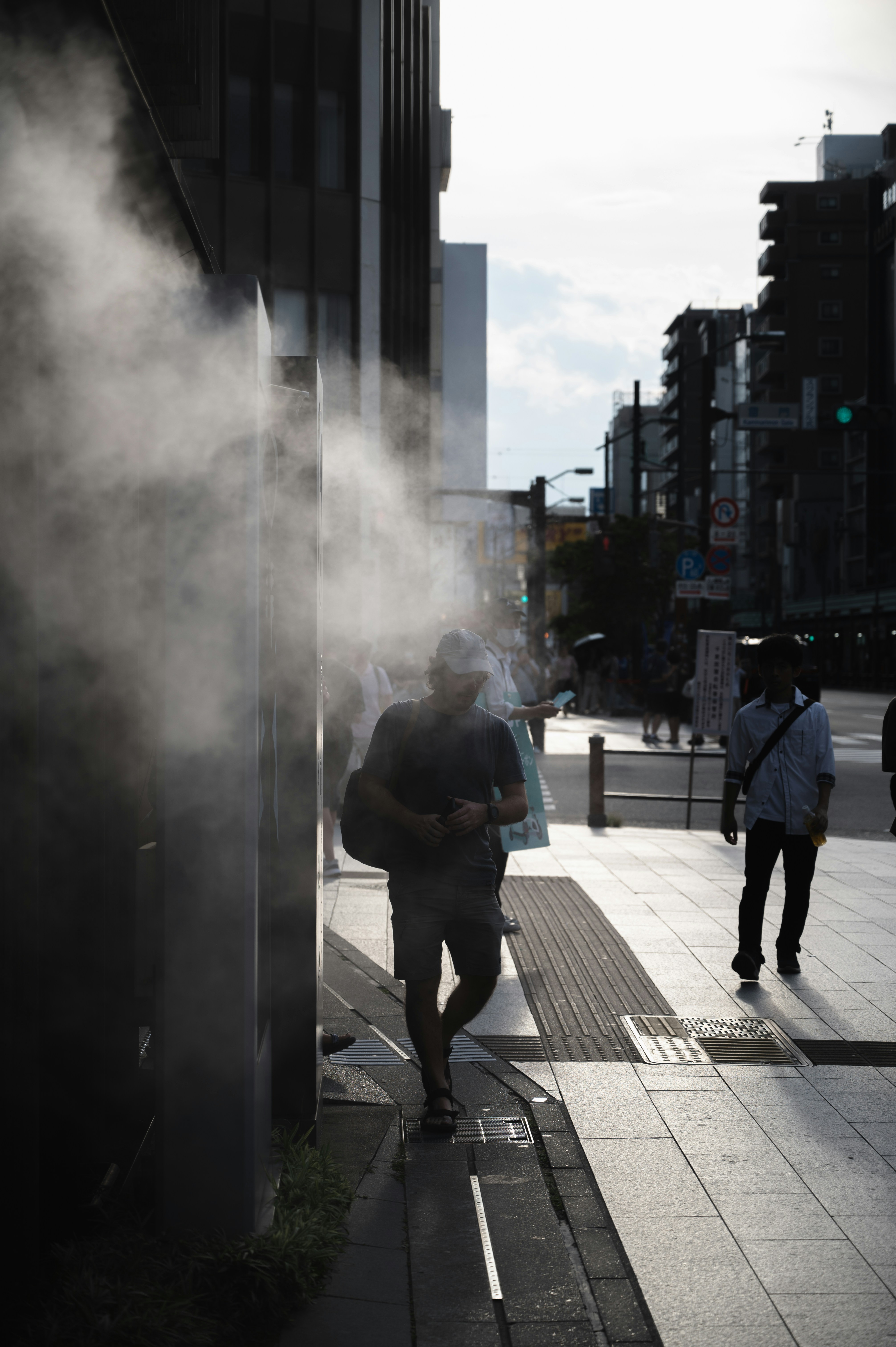 Steam and Stride: A Quiet Moment on a Busy Street