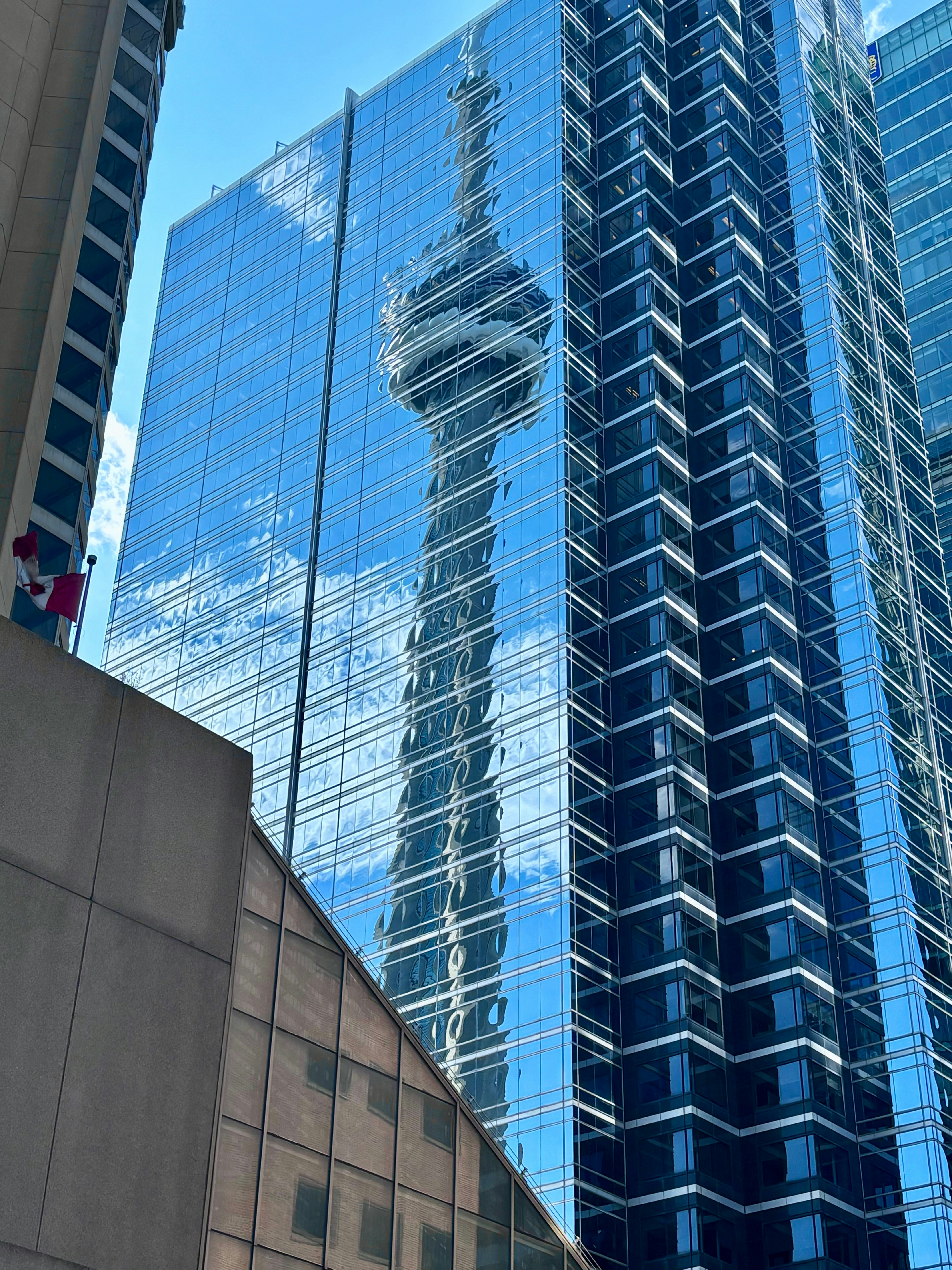 Mirror Tower: Reflection of a Skyward Spire on a Glass Facade