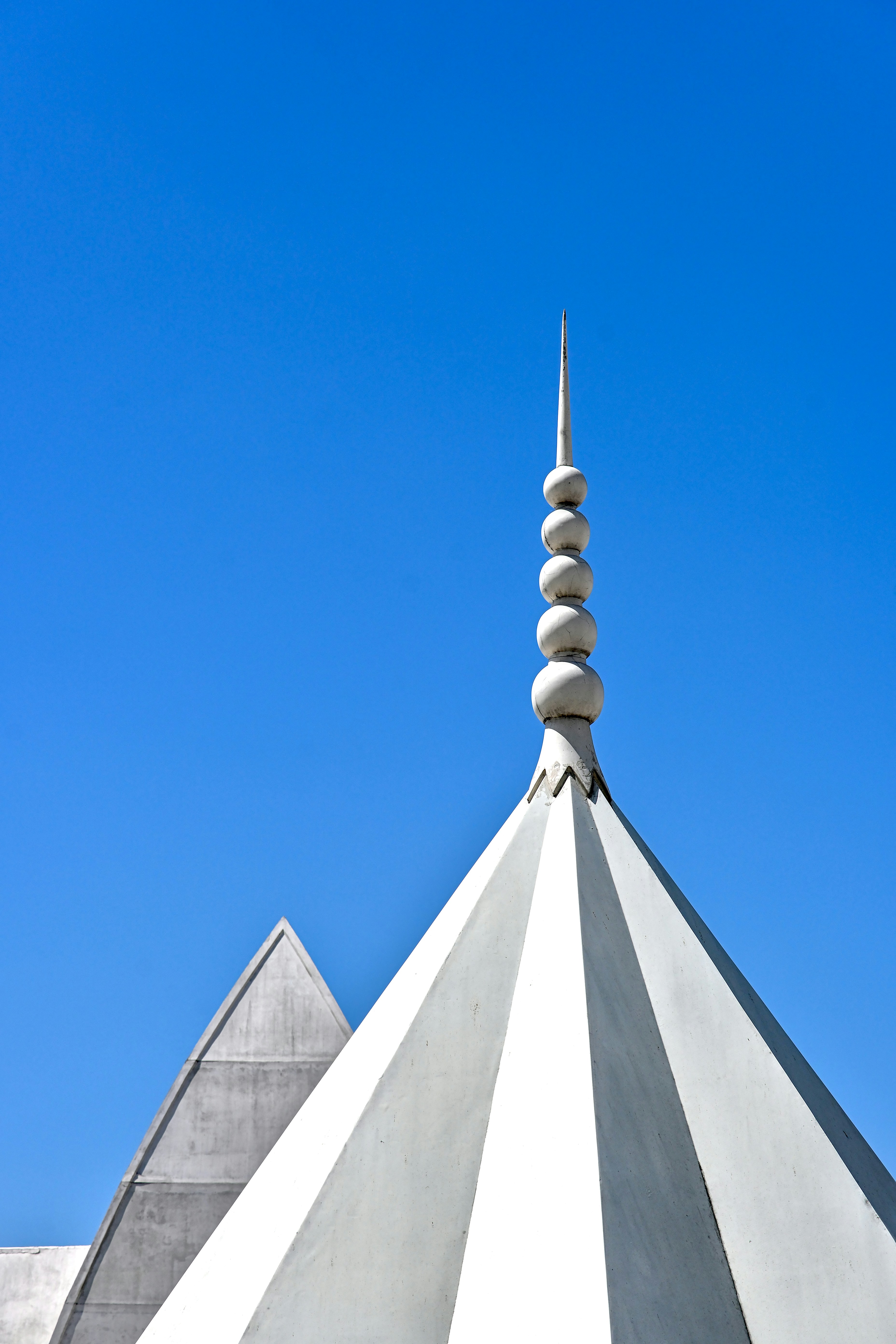 A tall white building with a pointed roof